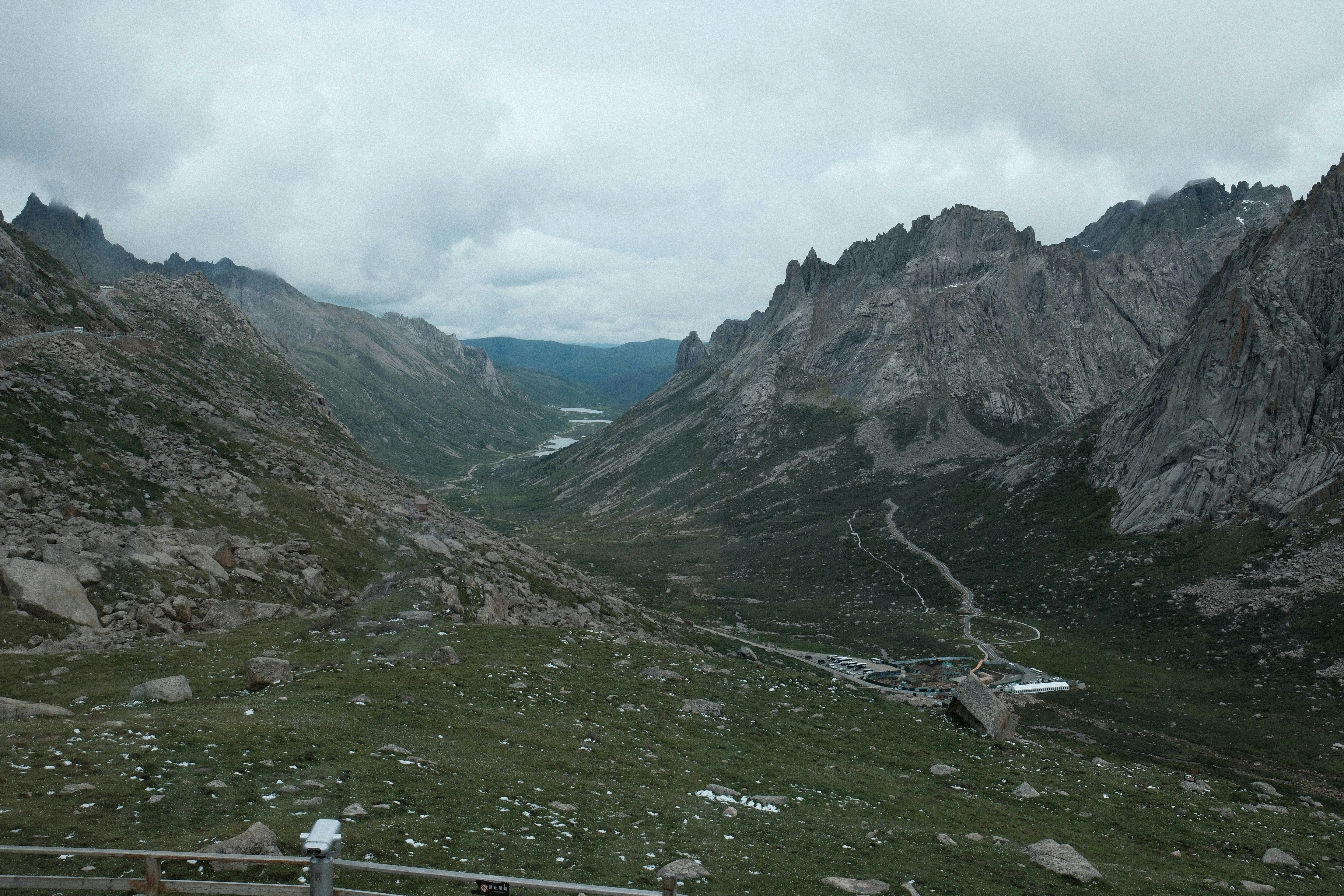 Rugged mountain valley with a winding road and river