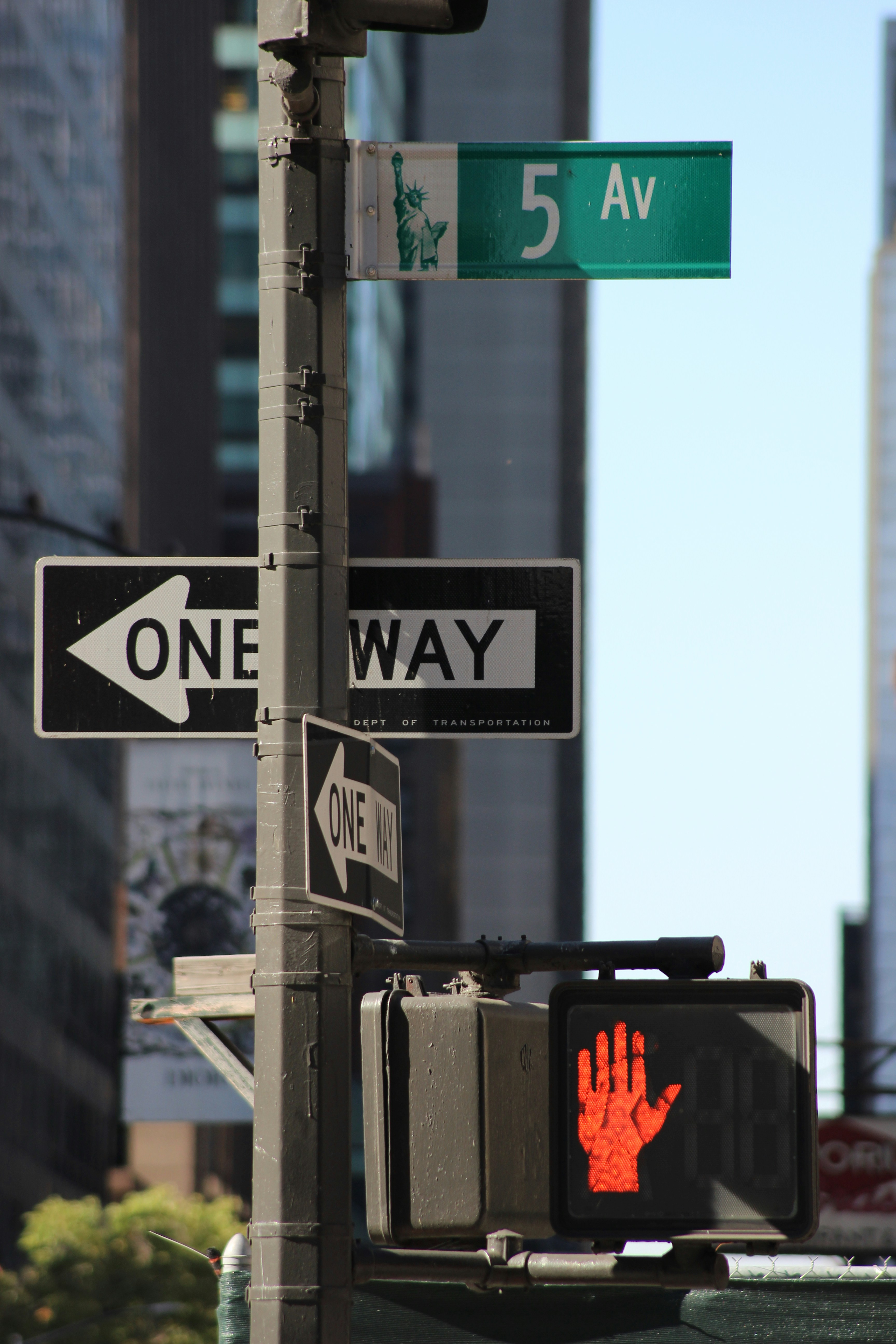 New York, oct 2025 | Street signs and traffic signals on a city street.