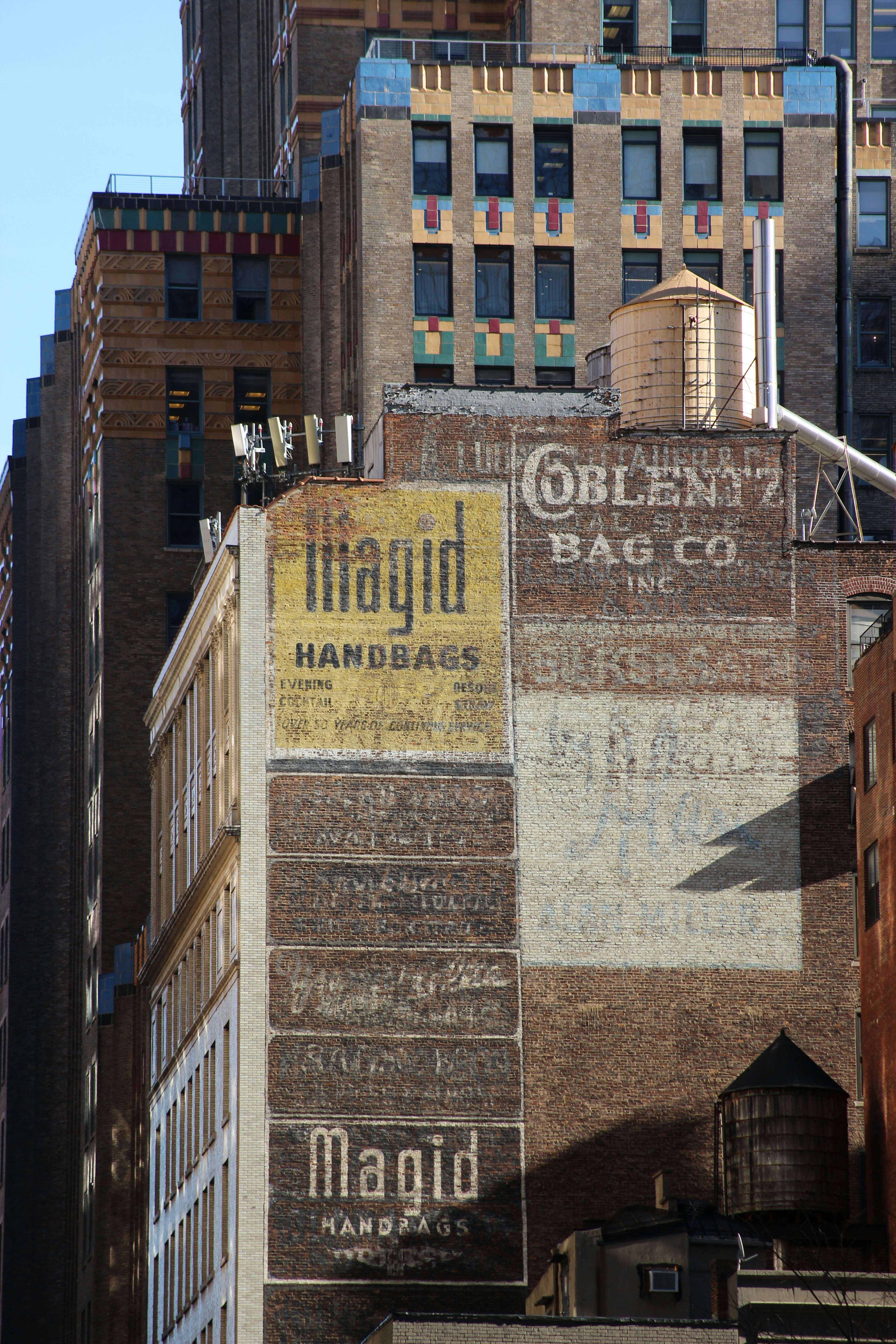 New York, oct 2025 | Old brick buildings with vintage advertisements for handbags.