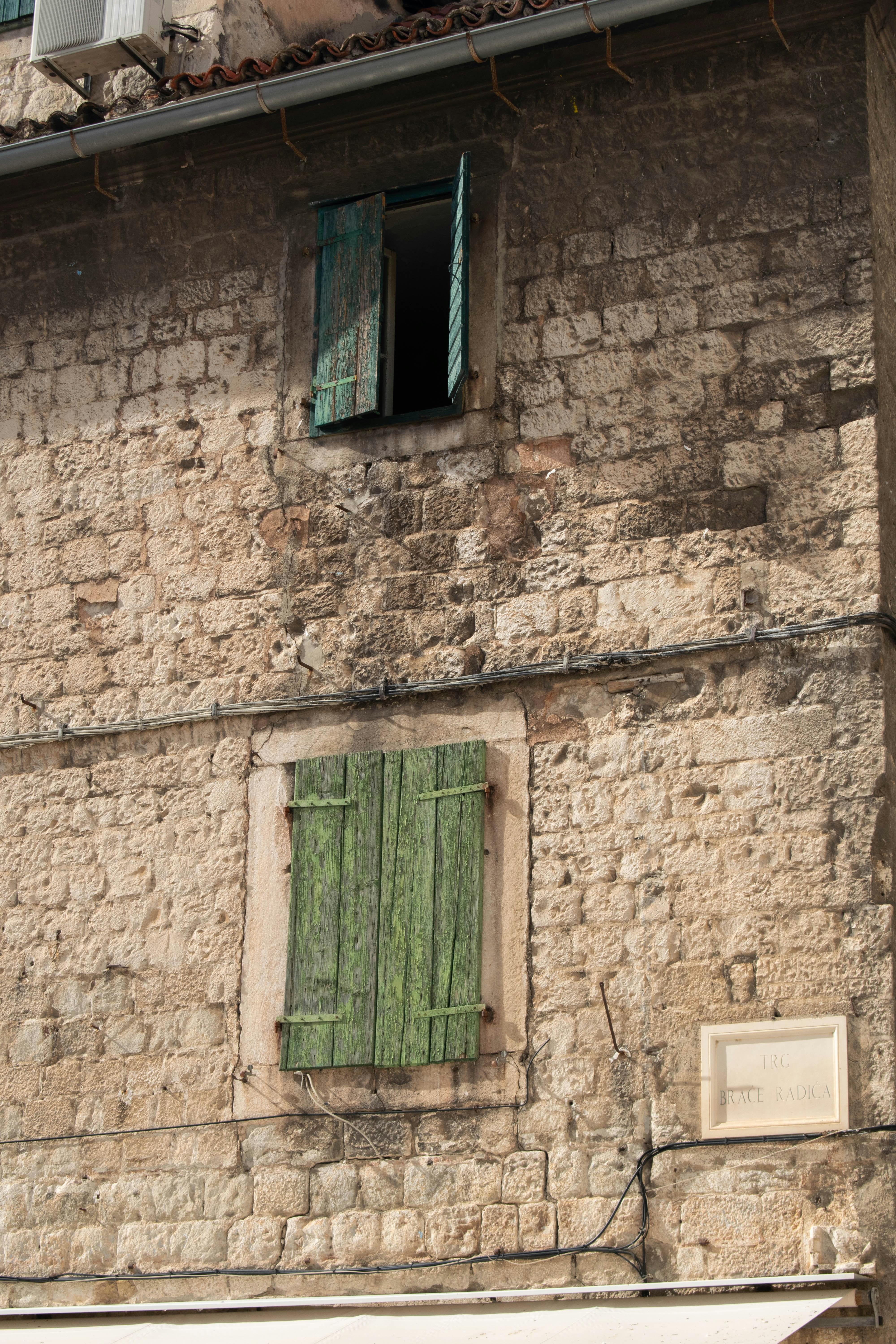 Whispers of Time: The Green Shuttered Facade