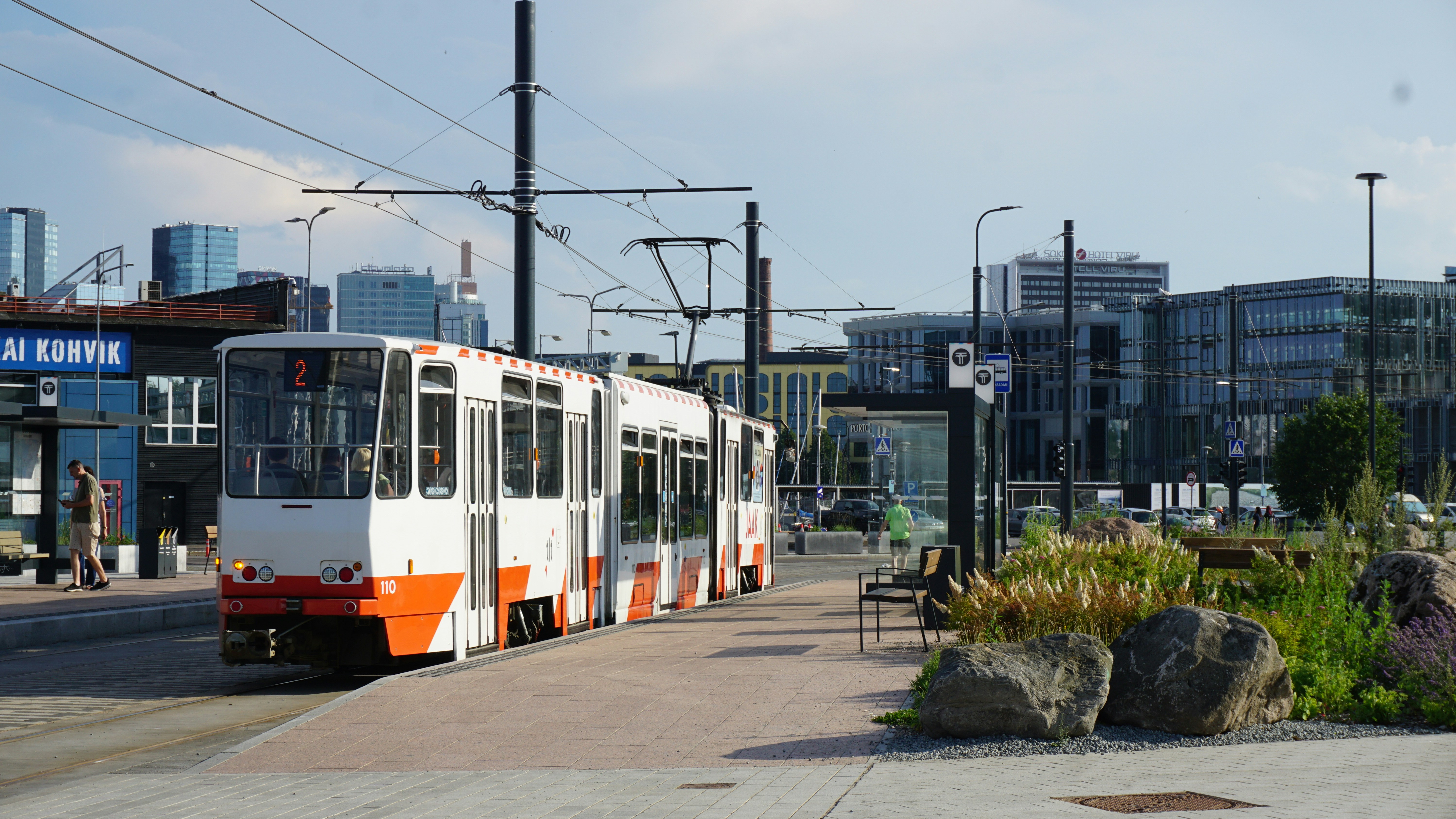 Tram navigating through a modern urban landscape, showcasing a blend of transportation and architecture.