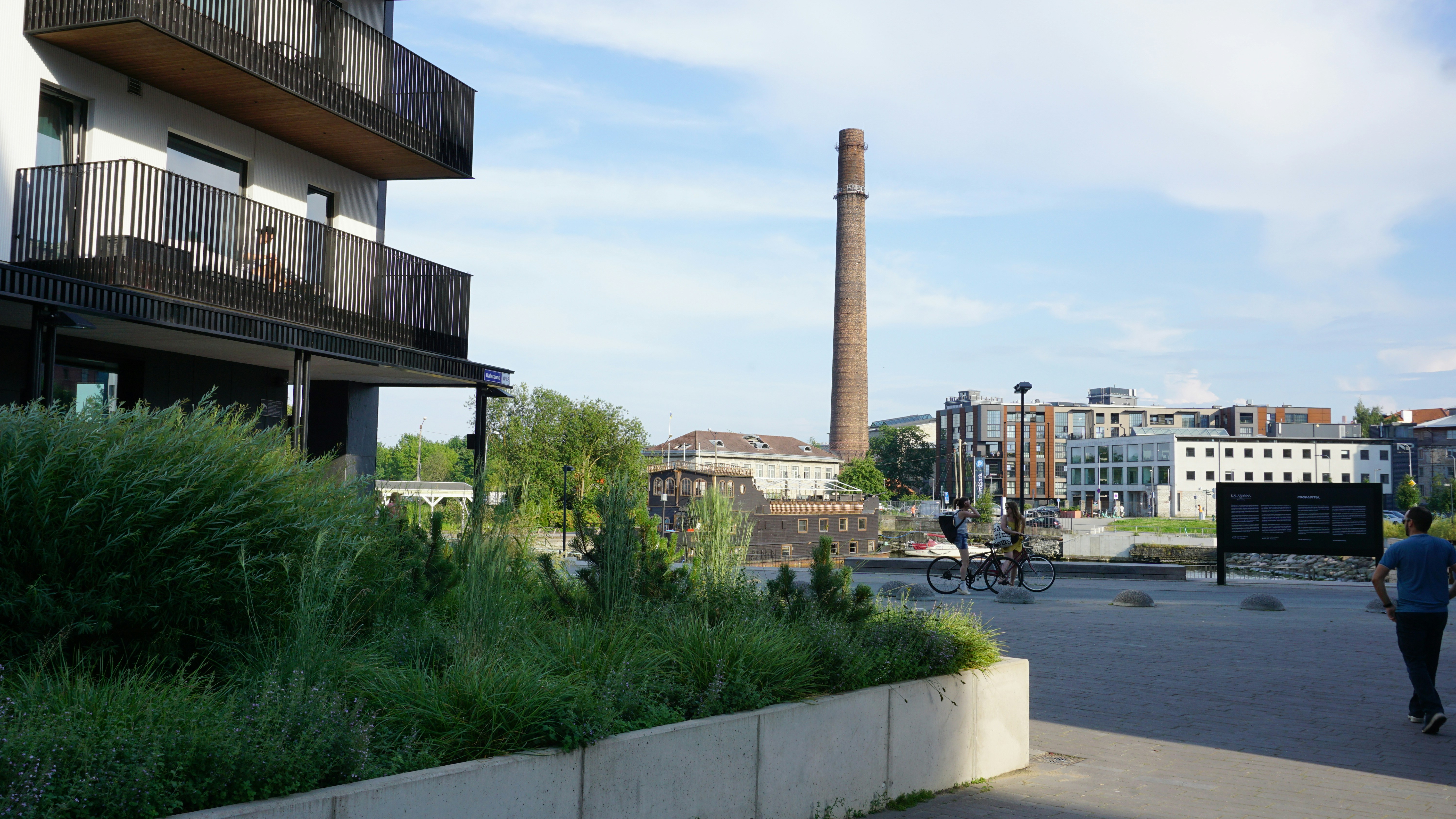 Modern building beside industrial chimney and cityscape