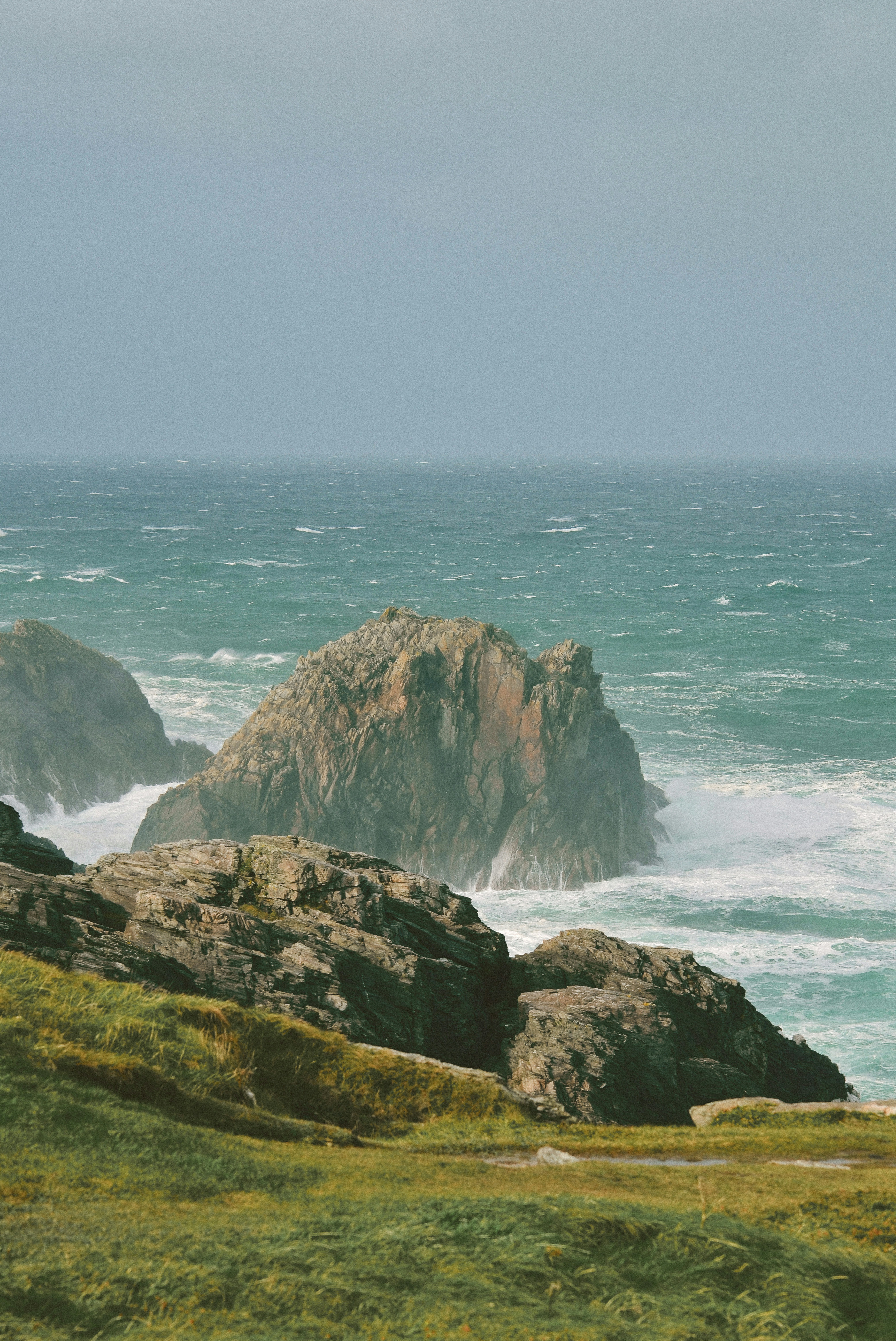 Rough waves crash against rocky coastal formations
