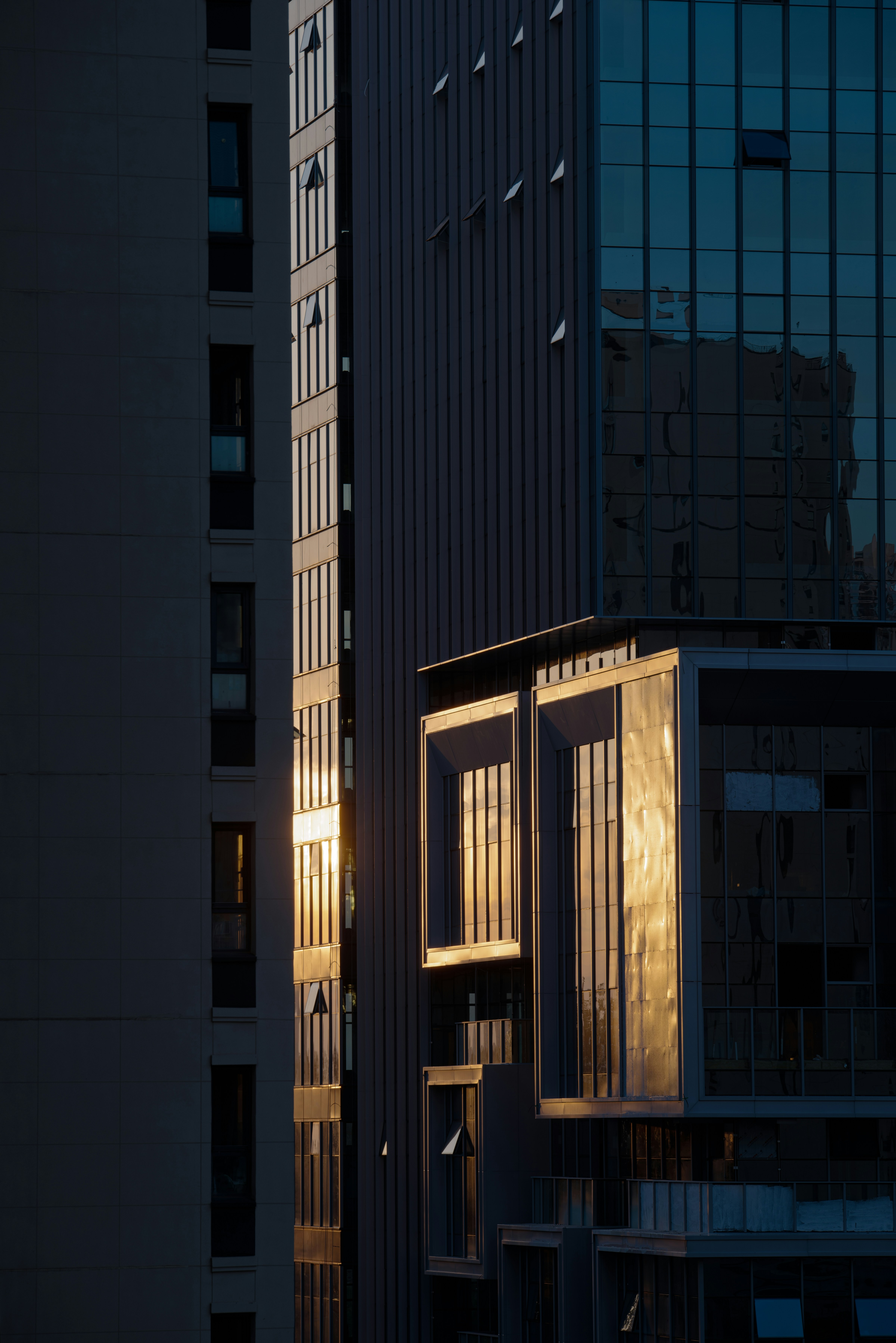 The first ray of sunlight shines on the building | Modern buildings with sunlight reflecting on windows.