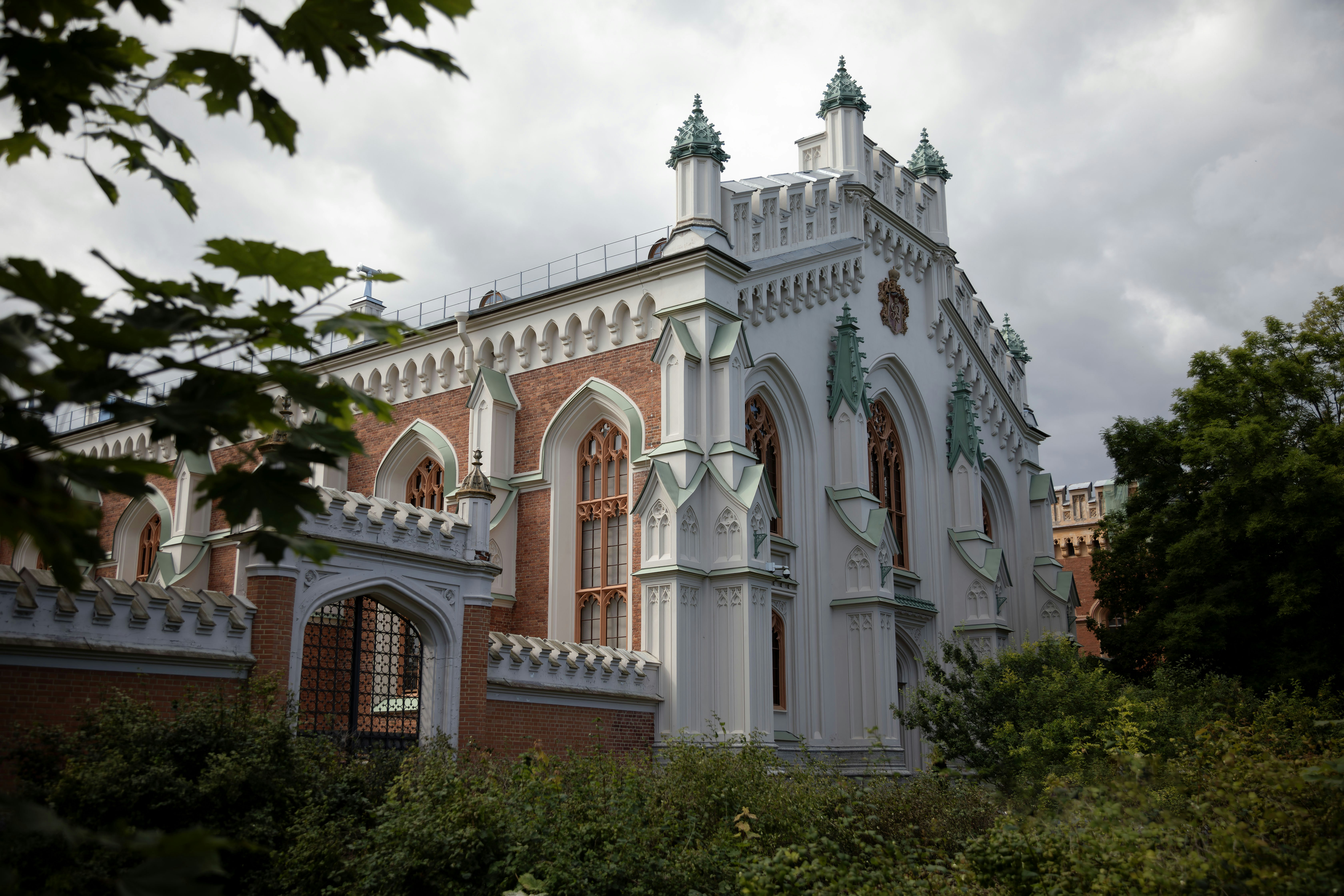 Palace Stables, Peterhof | Ornate gothic building with white and red walls