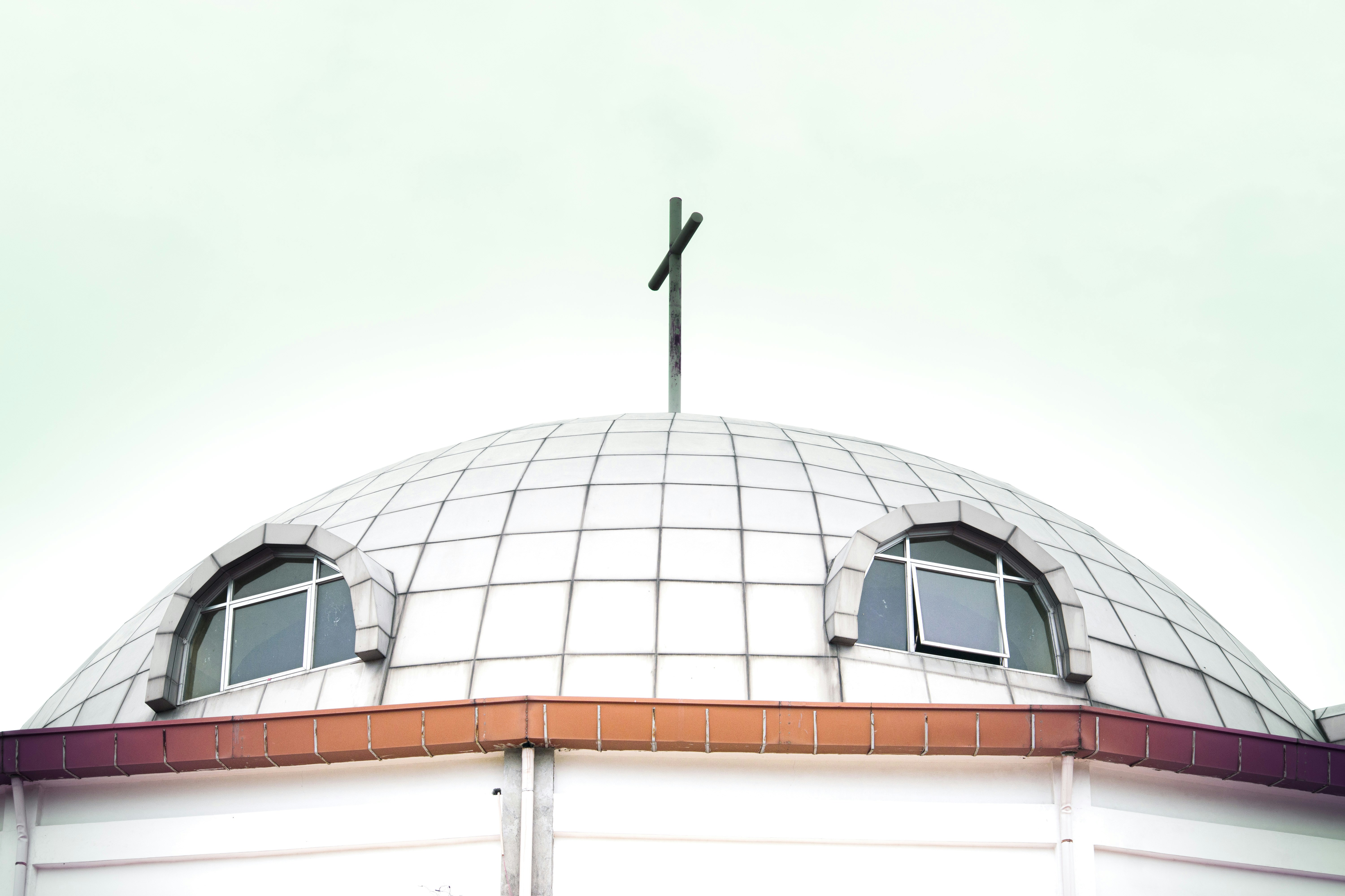Church dome with cross against a pale sky