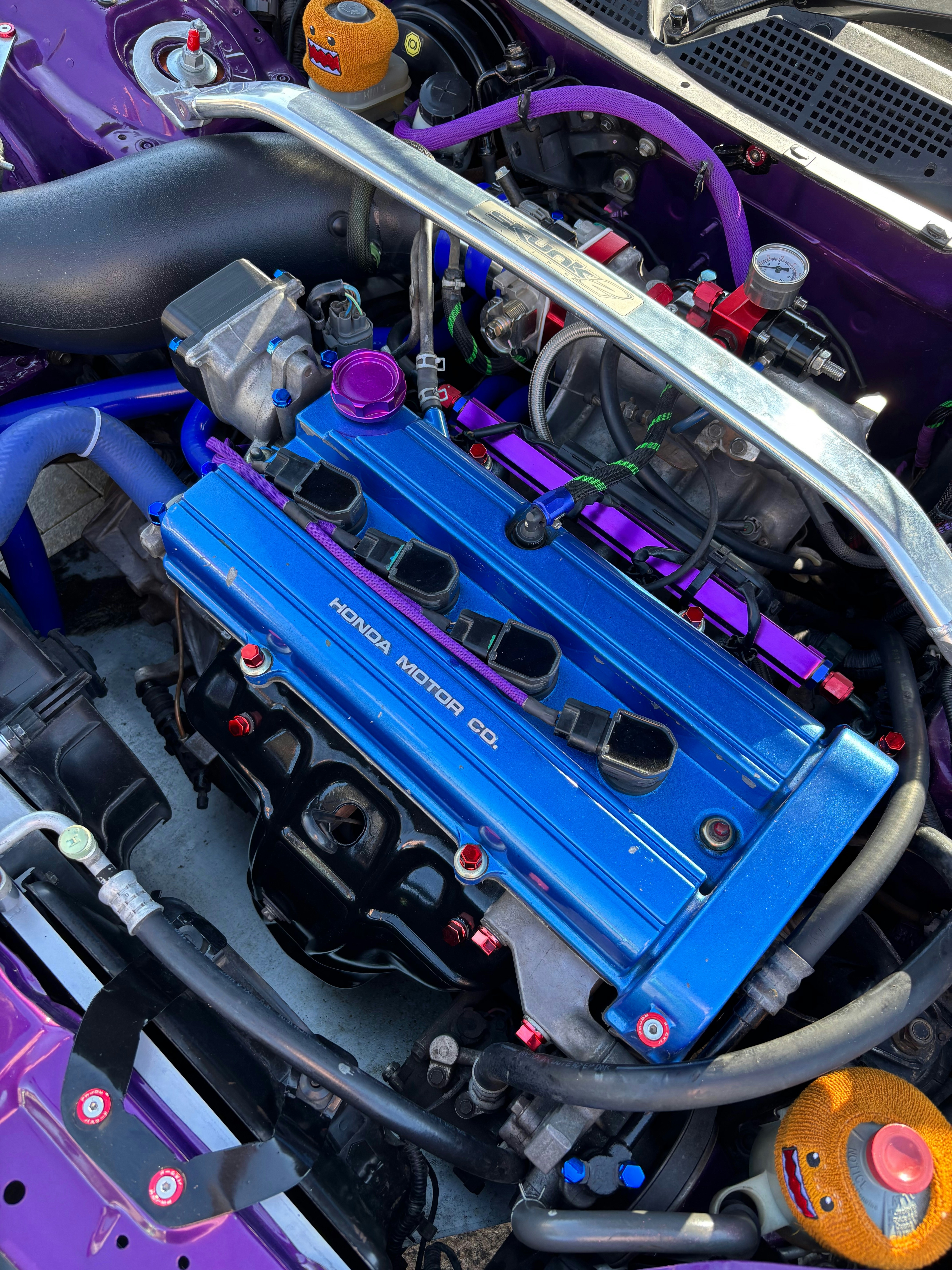 Customized blue honda engine with purple accents