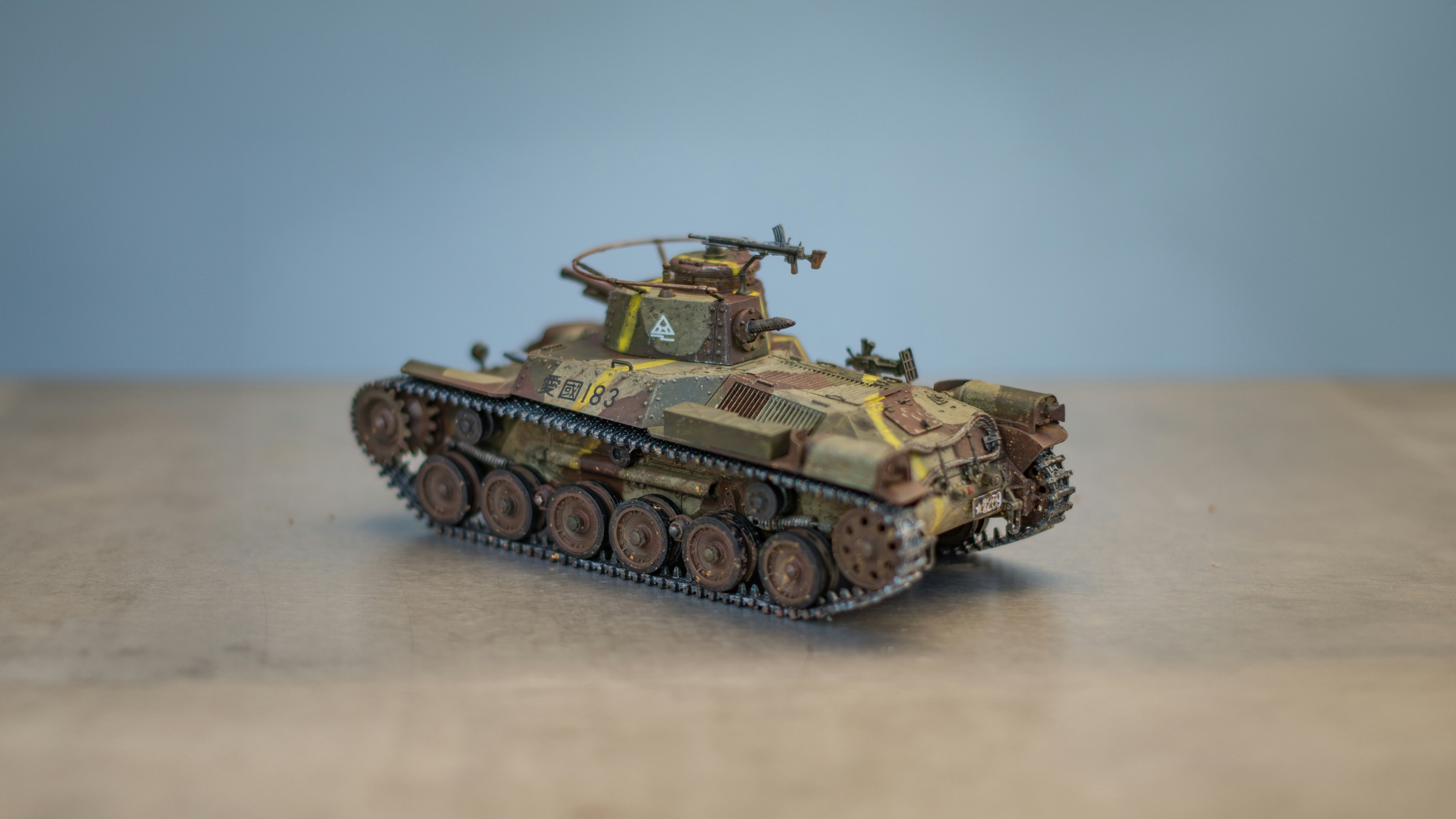 My Type 97 Chi-Ha tank (1:35) scale model from Tamiya | A detailed model of a camouflage tank on a wooden surface.