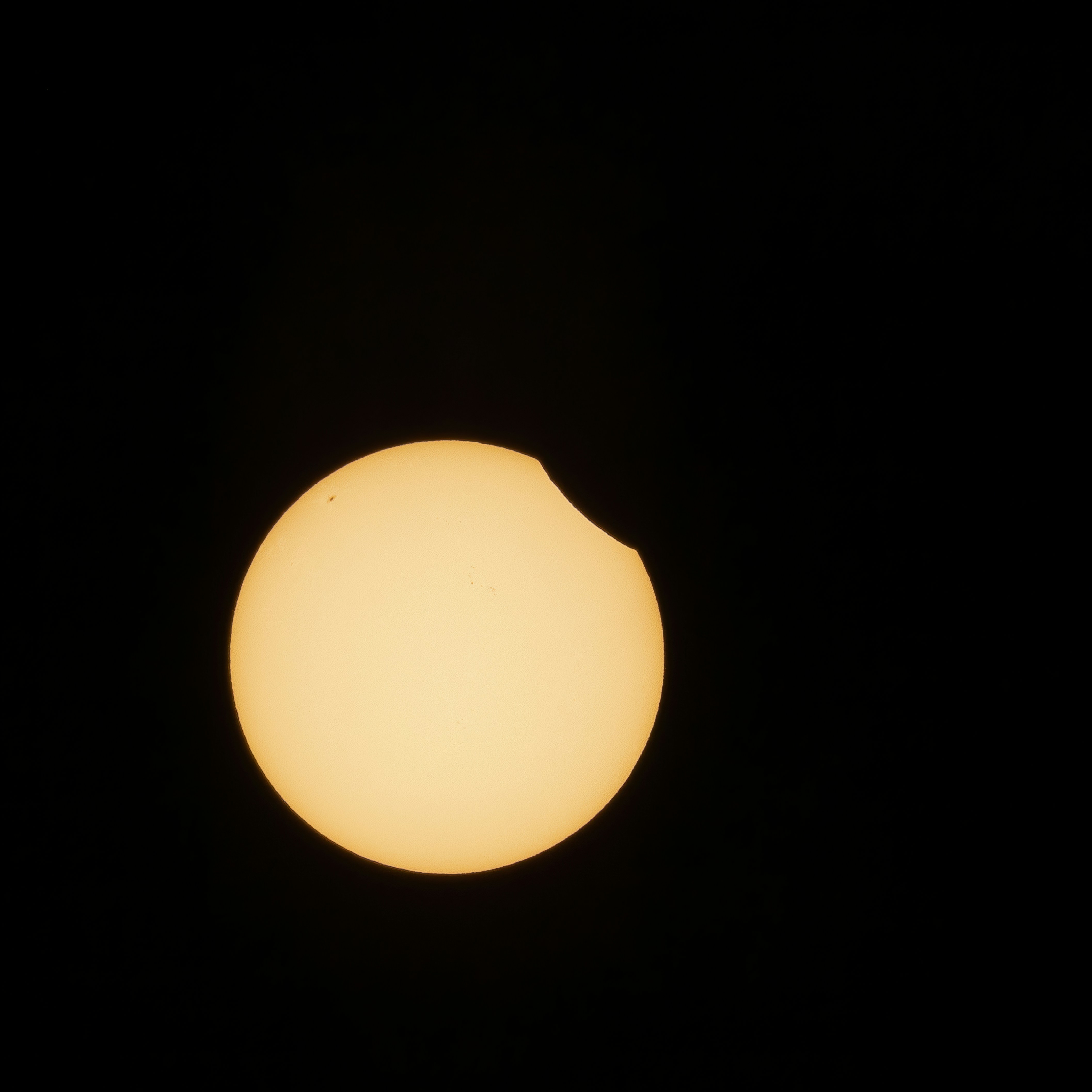 Partial solar eclipse with sun obscured by moon.