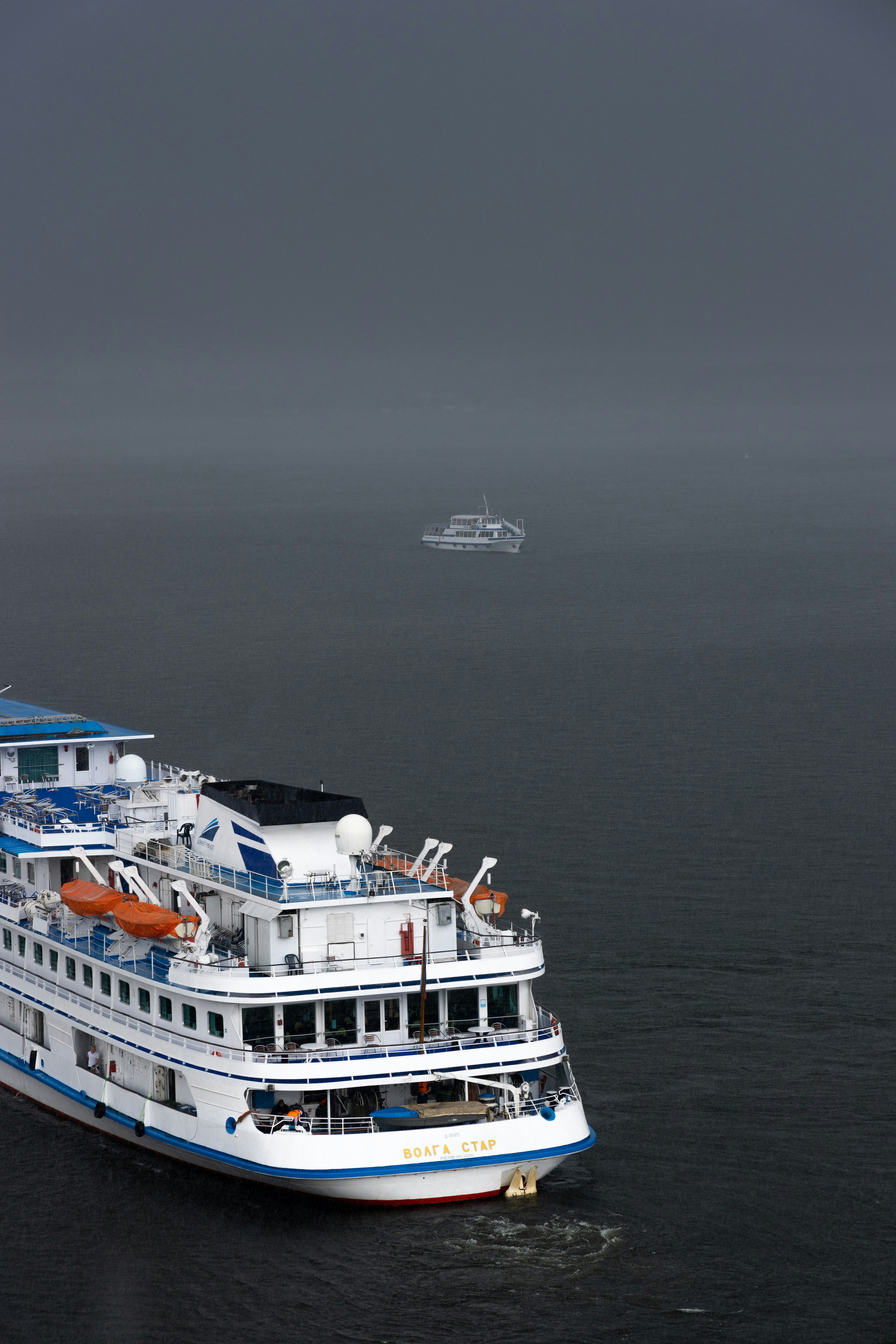 White cruise ship sailing on foggy water
