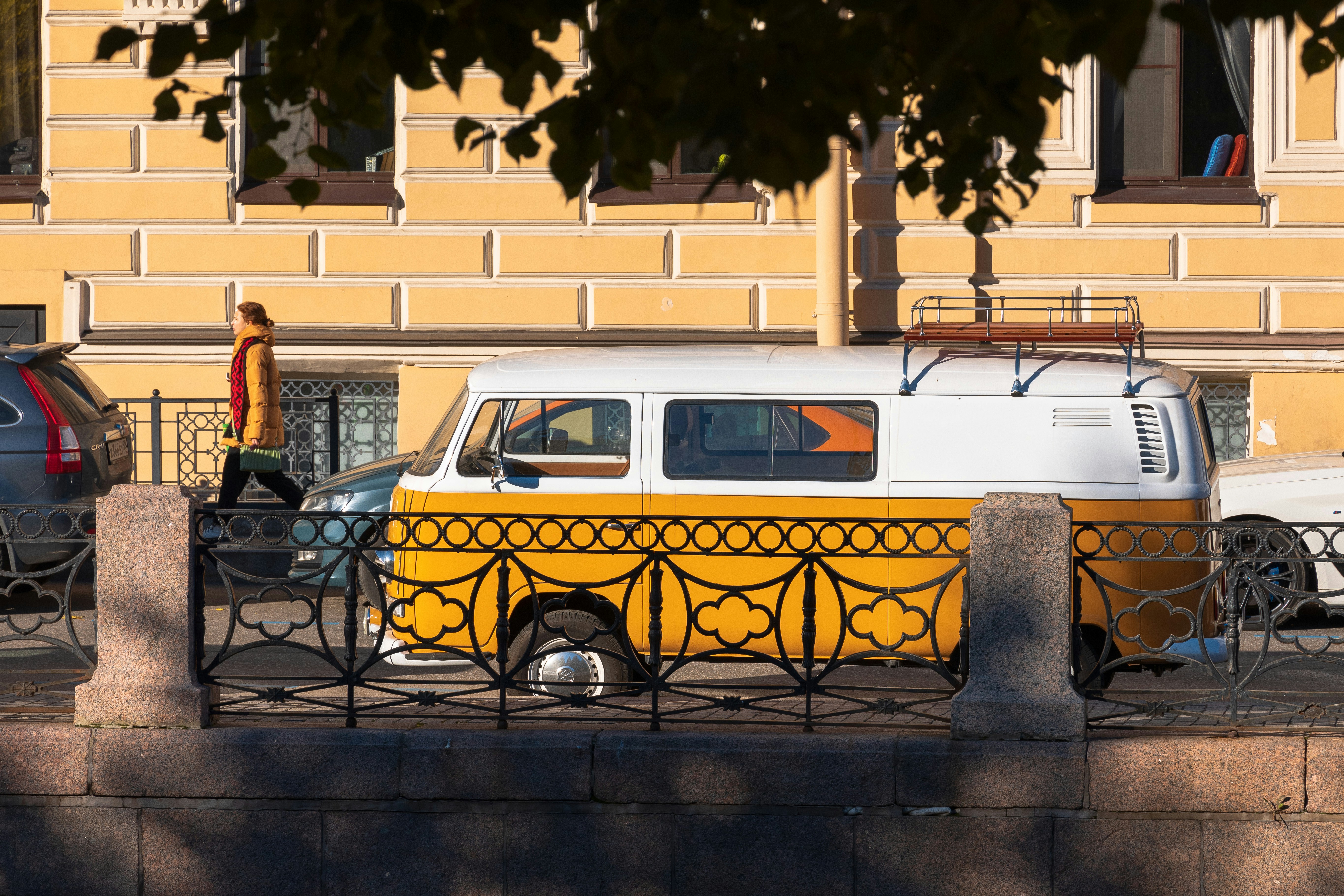Van with yellow decorative pattern parked near building