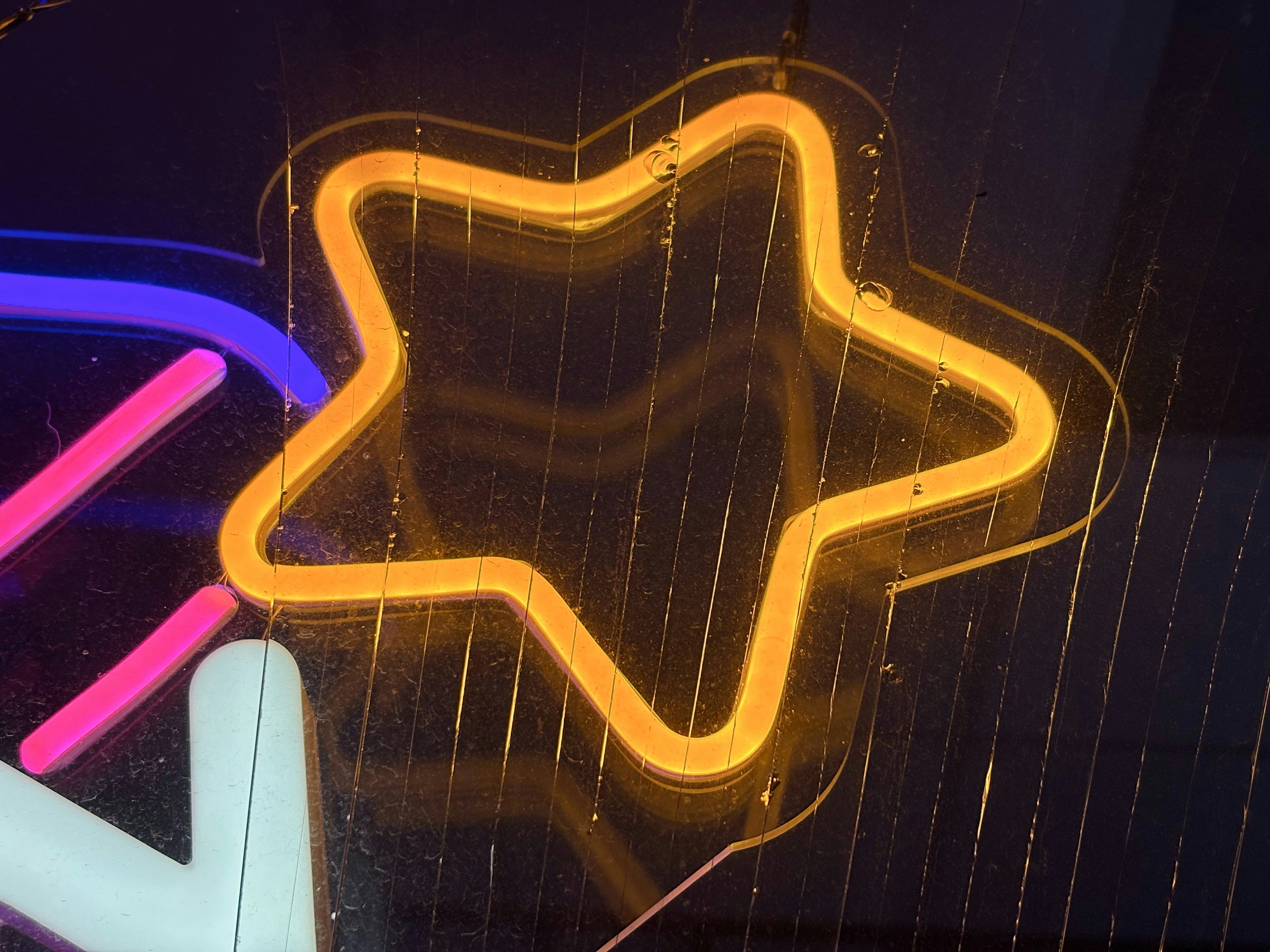 Orange neon star glowing in the dark