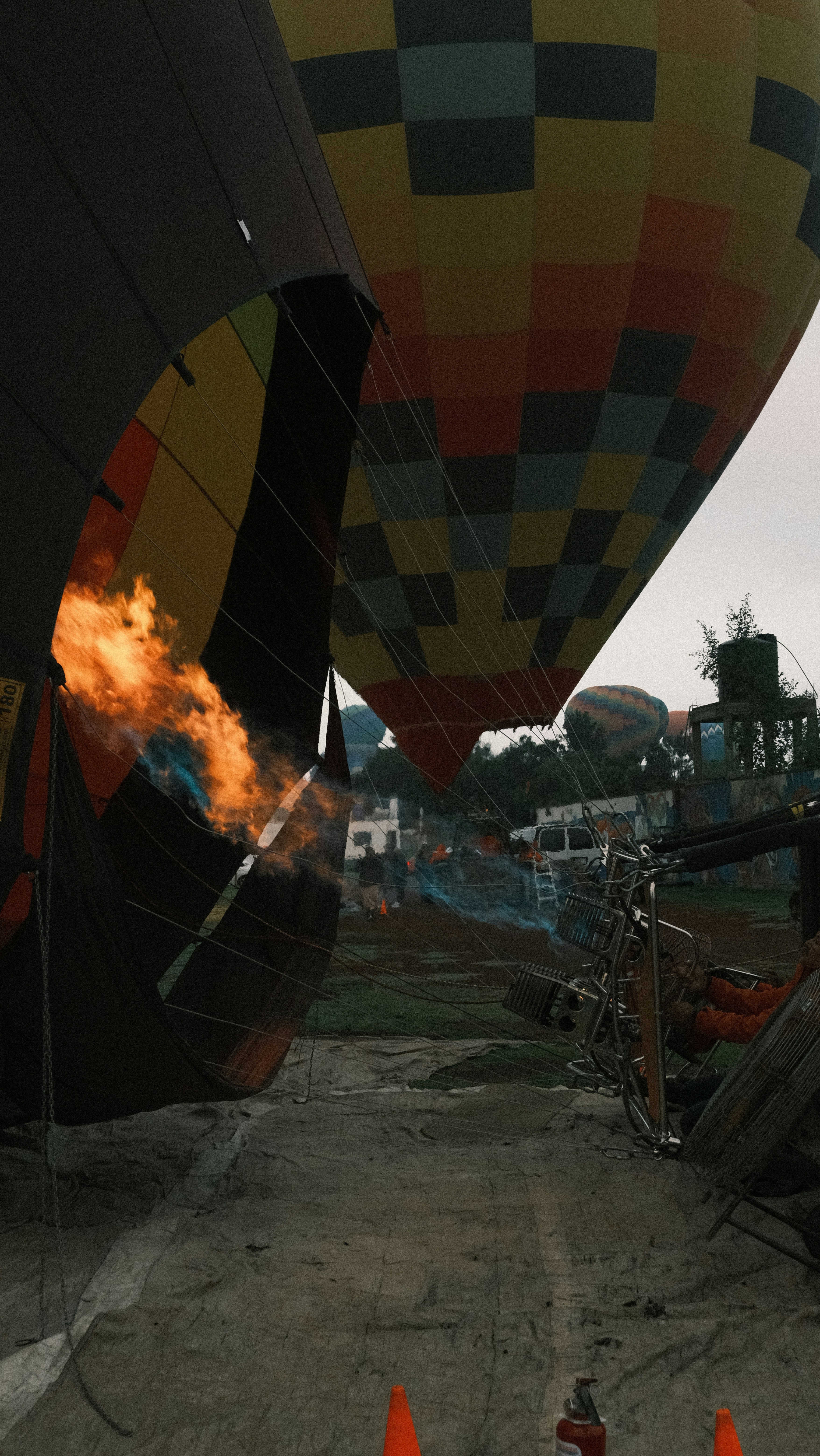 Hot air balloons being inflated with flames.