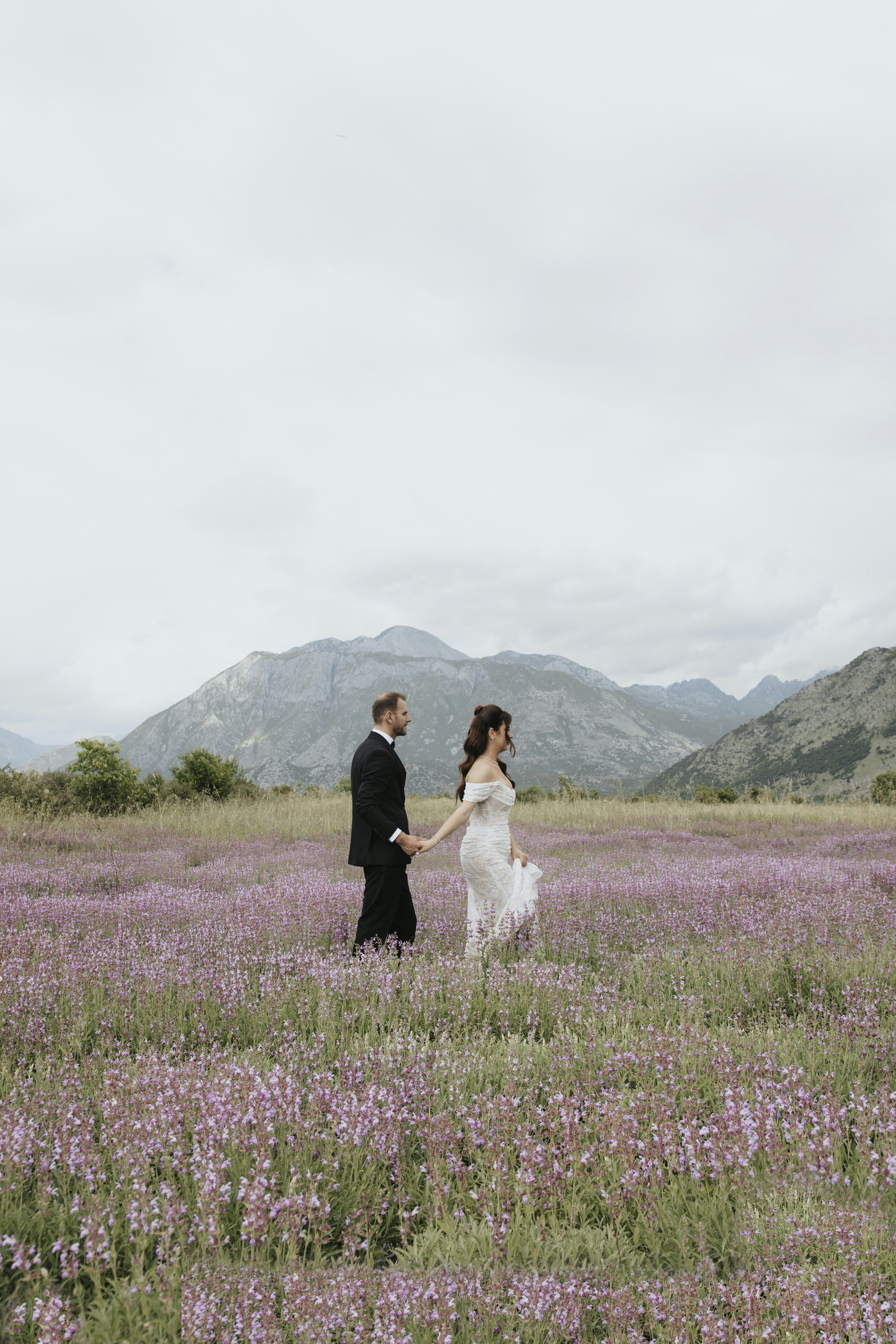 Vows in a Pink-Flowered Field Before Mountain Peaks