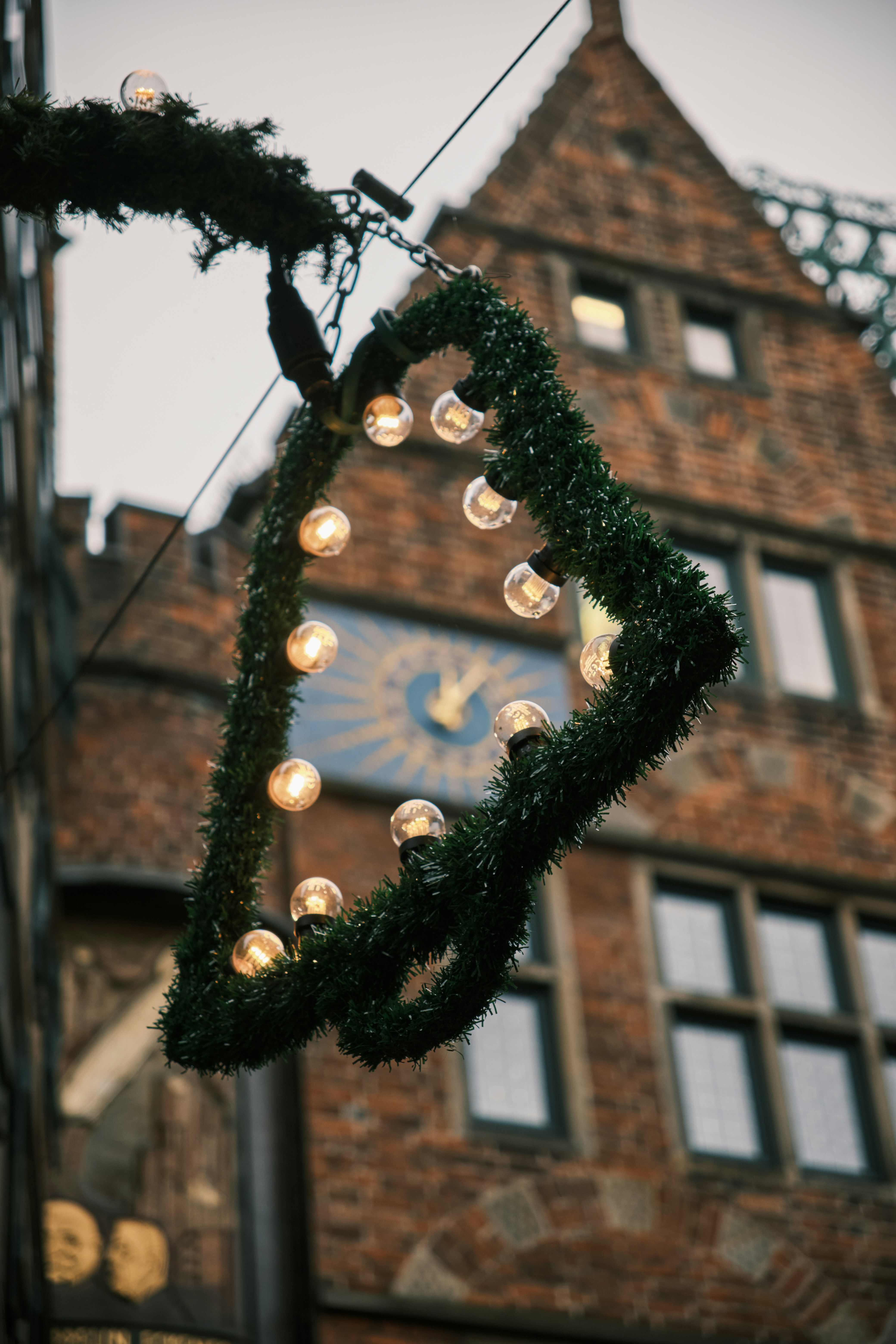 Christmas wreath with lights on building background building facade