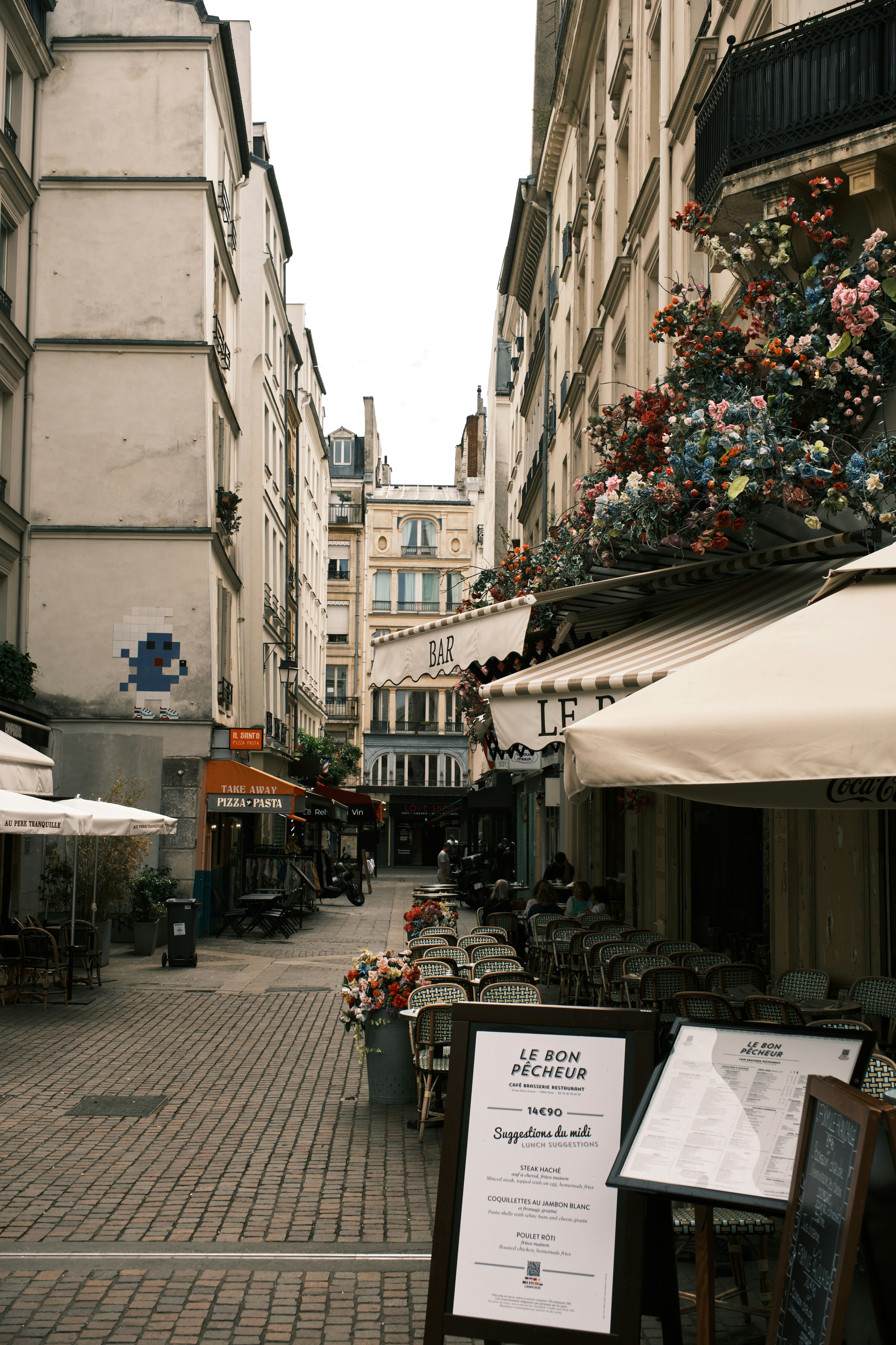 Narrow parisian street with outdoor cafe seating
