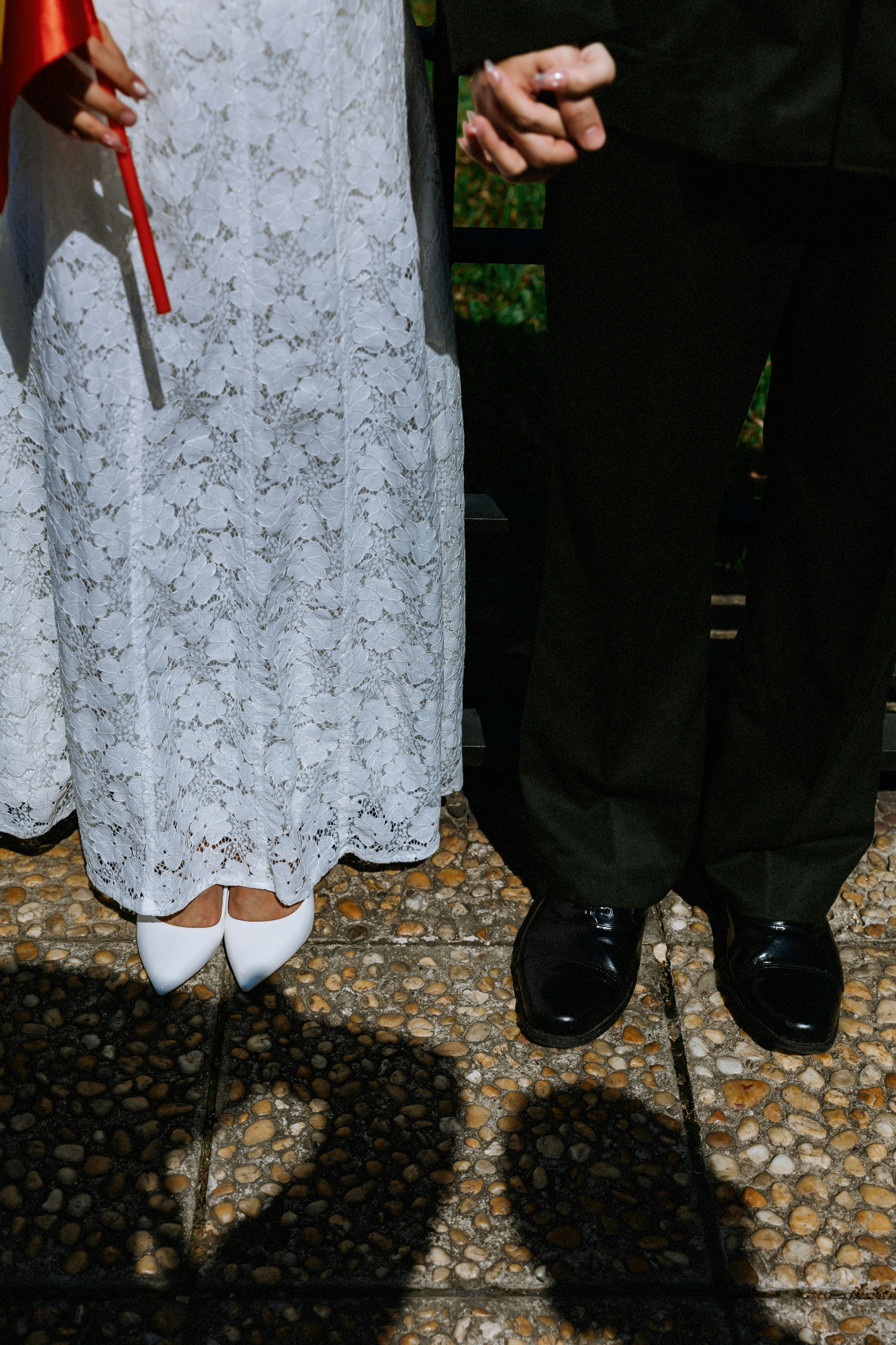 Couple portrait outdoors in Hanoi | Couple holding hands, dressed for a formal occasion.