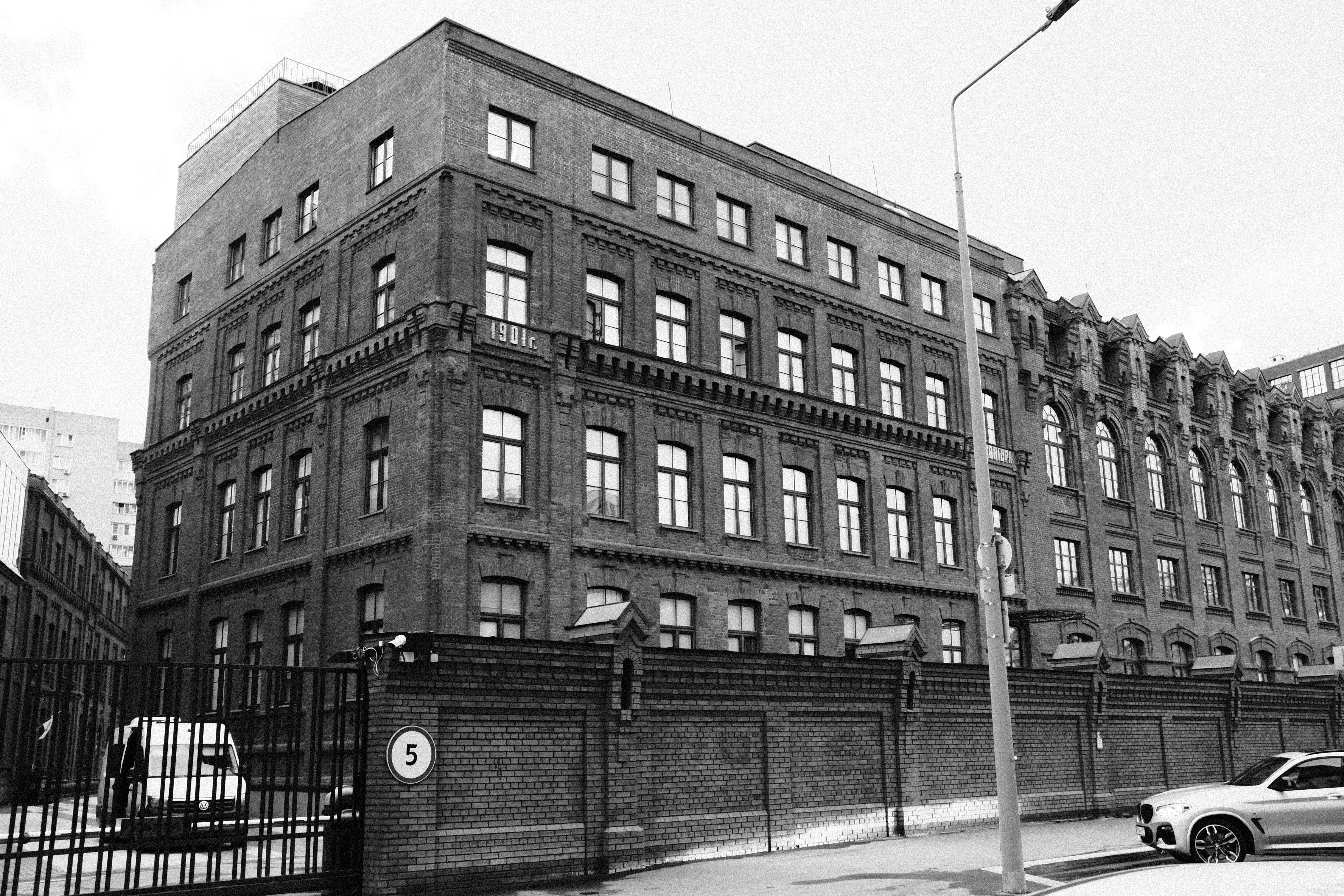 1901 | Large brick building with many windows and a fence