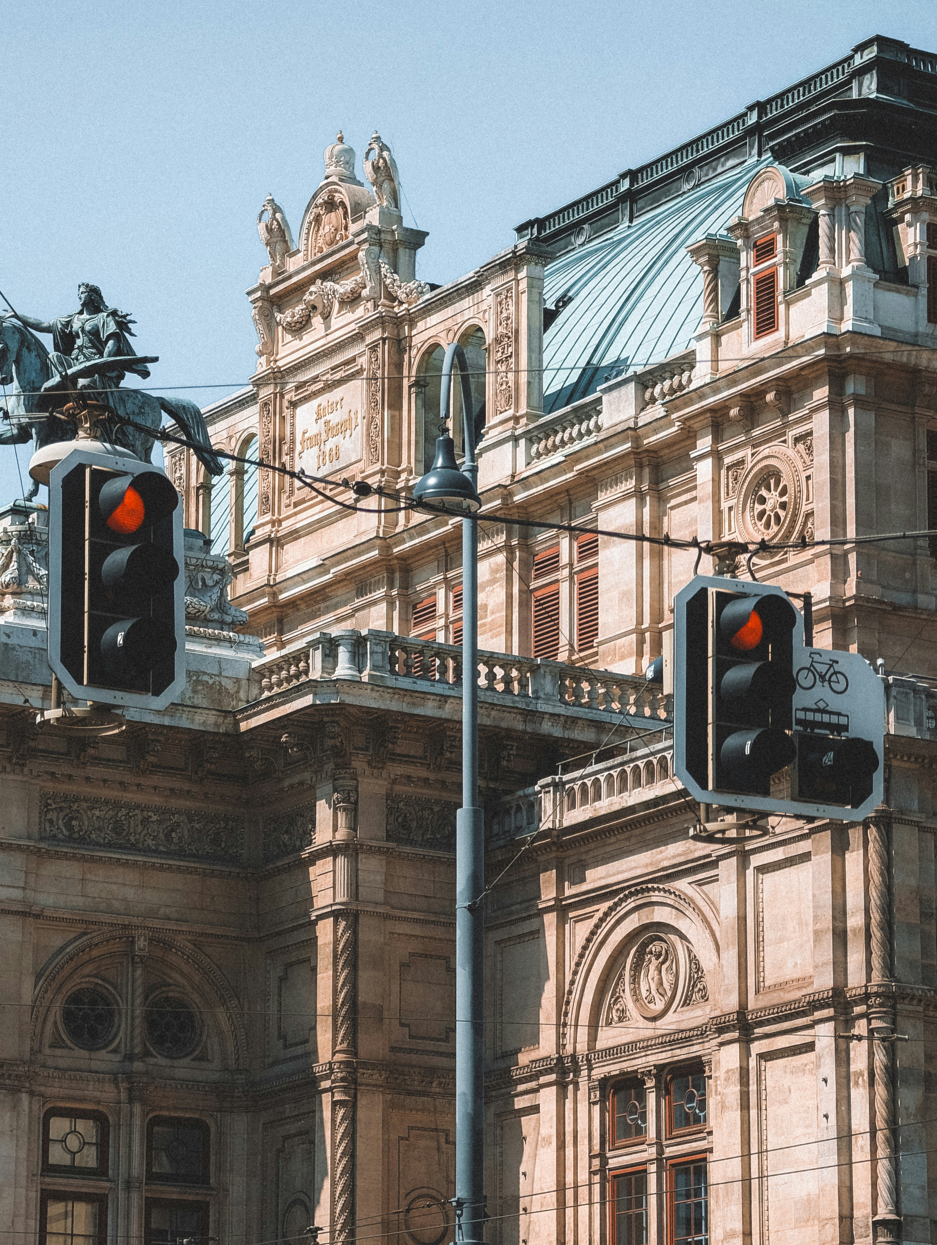 Historic opera house facade and traffic lights | Traffic lights in front of ornate building
