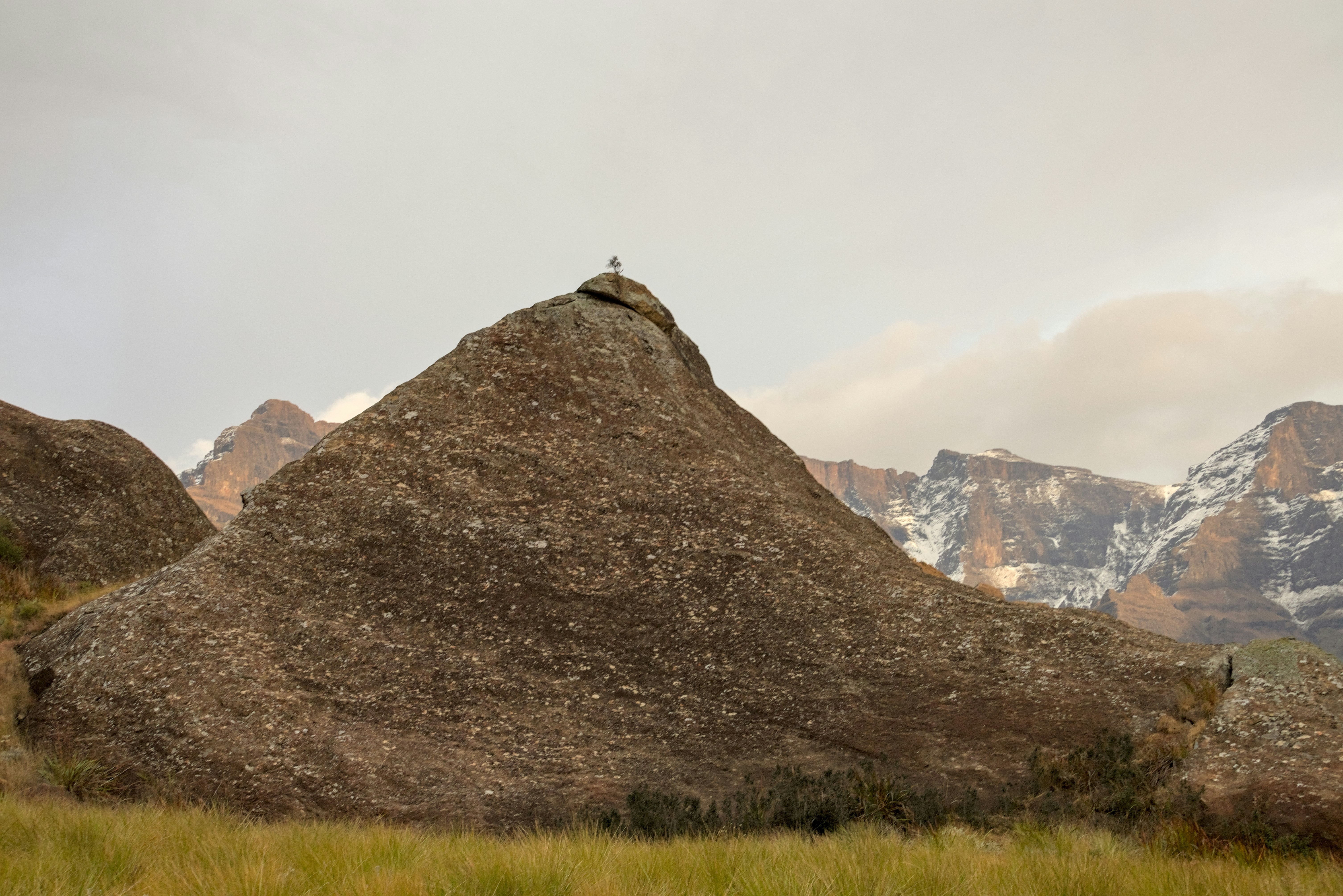 The Solitary Sentinel: A Rocky Outcrop Amidst Majestic Peaks