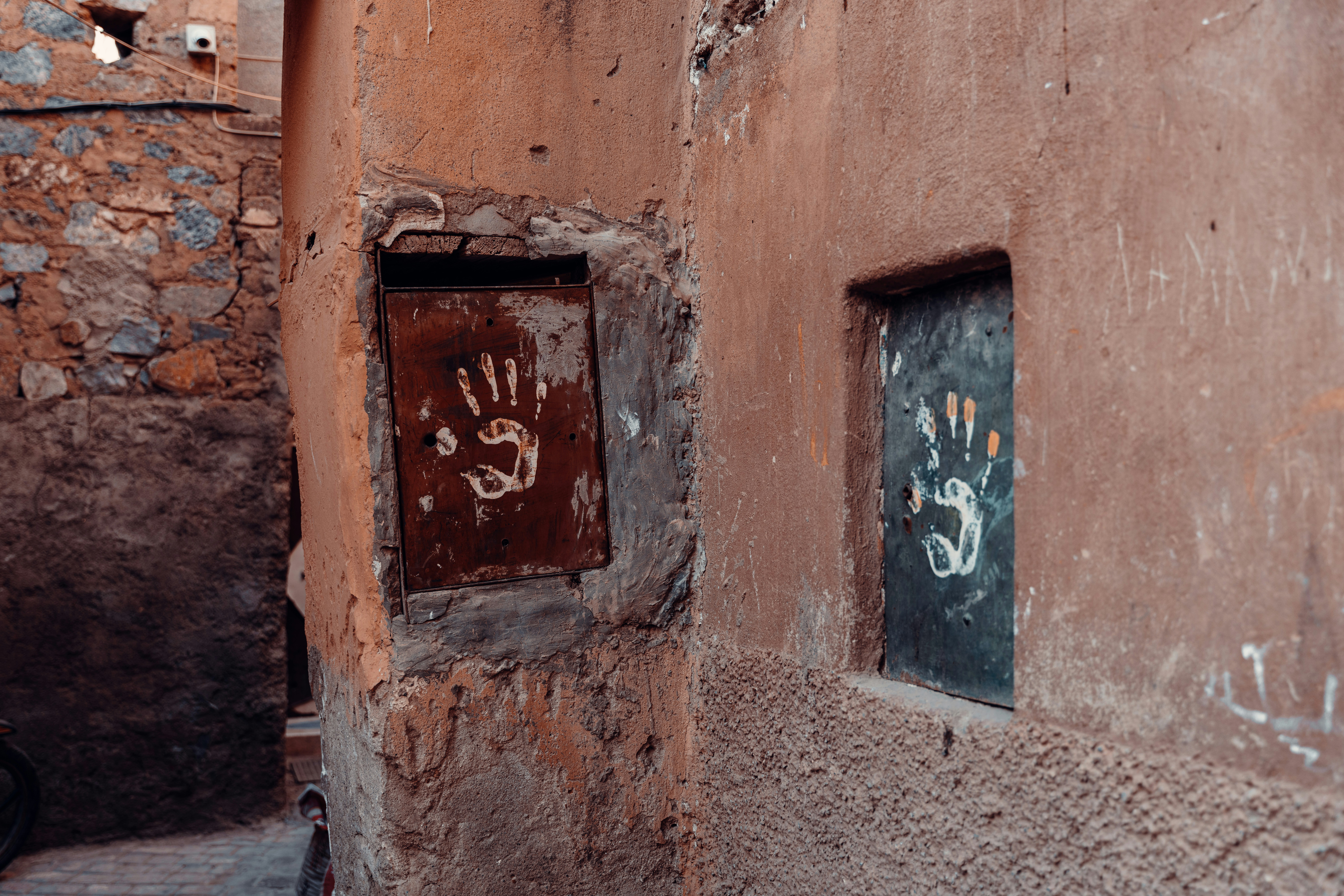 Twin Handprints in a Weathered Adobe Alley