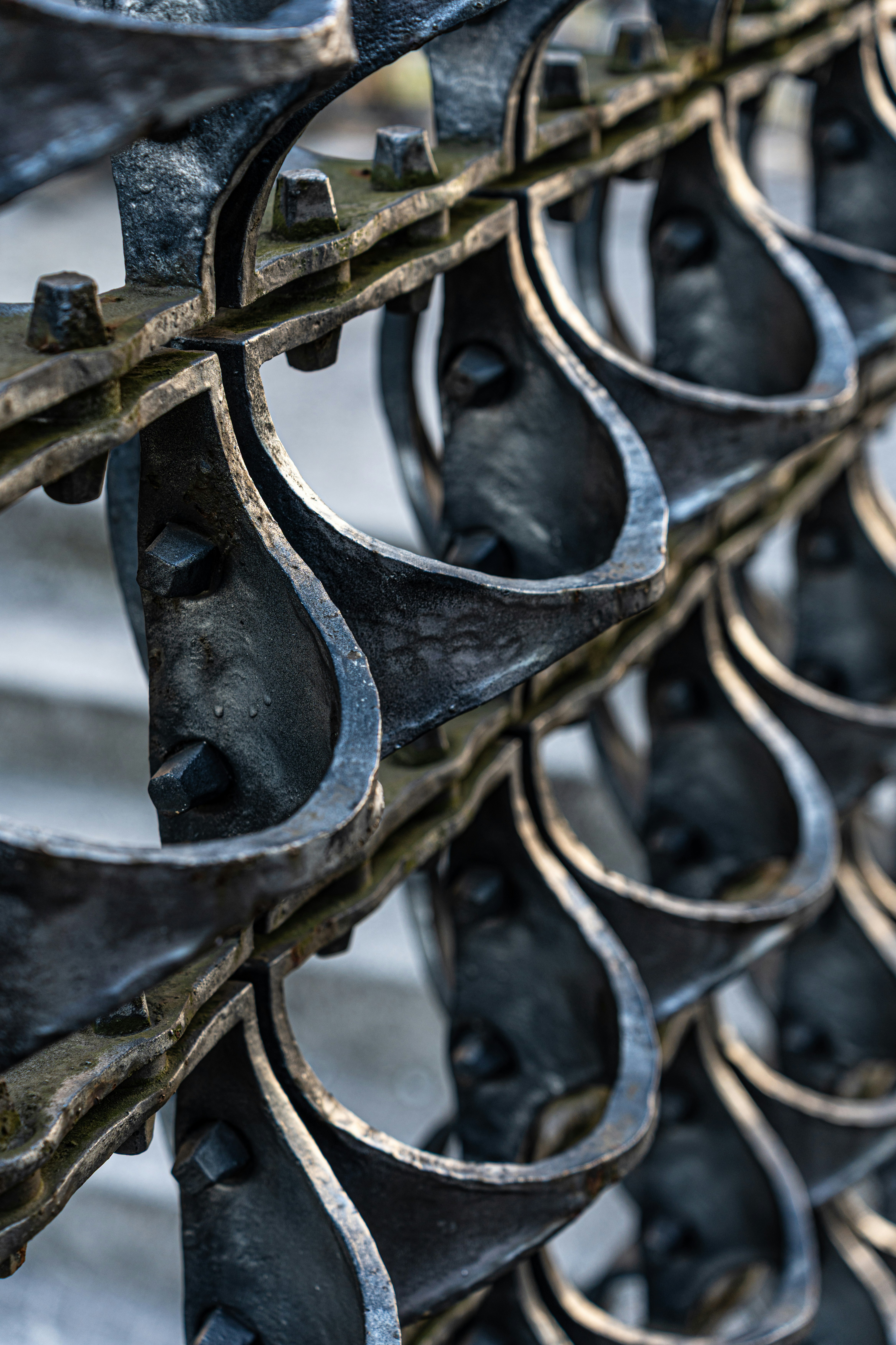Interwoven Iron: A Close-Up of Weathered Gears and Loops