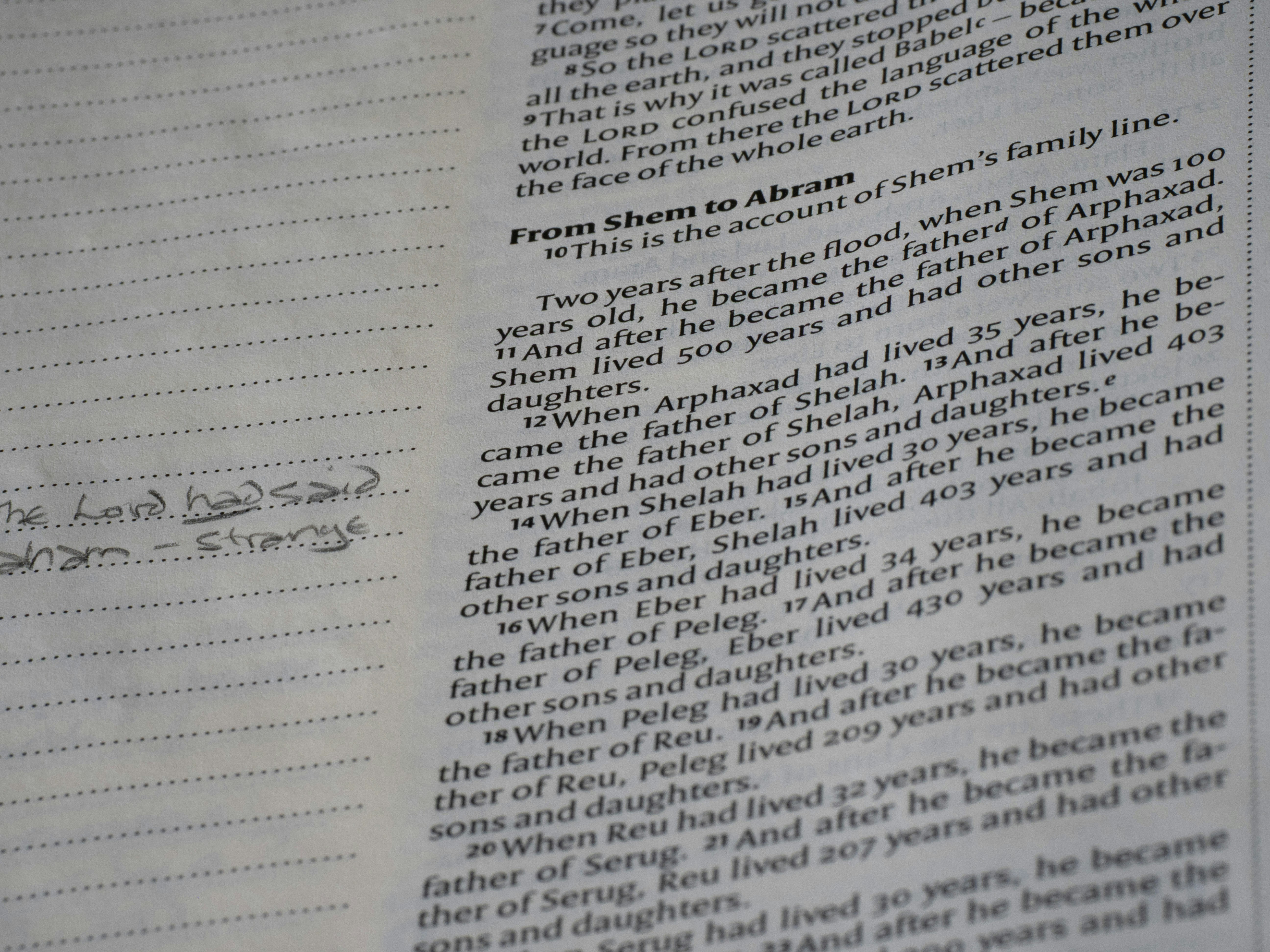 The Book of Genesis | Close-up of a bible page with handwritten notes.