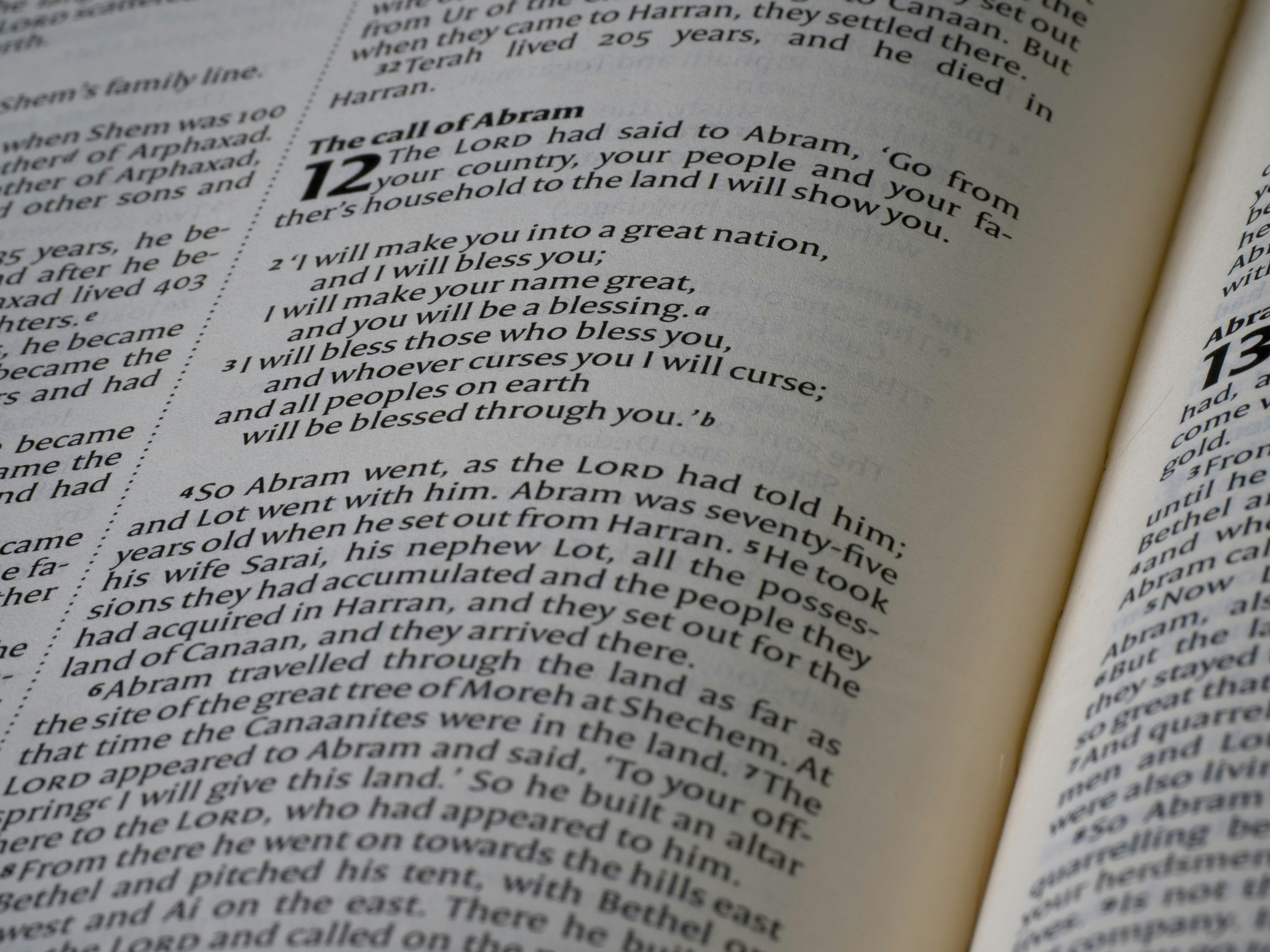 Close-up of a page from a religious text, featuring the story of Abram's call and the promise of blessings. The text is intricately detailed and shows signs of use.