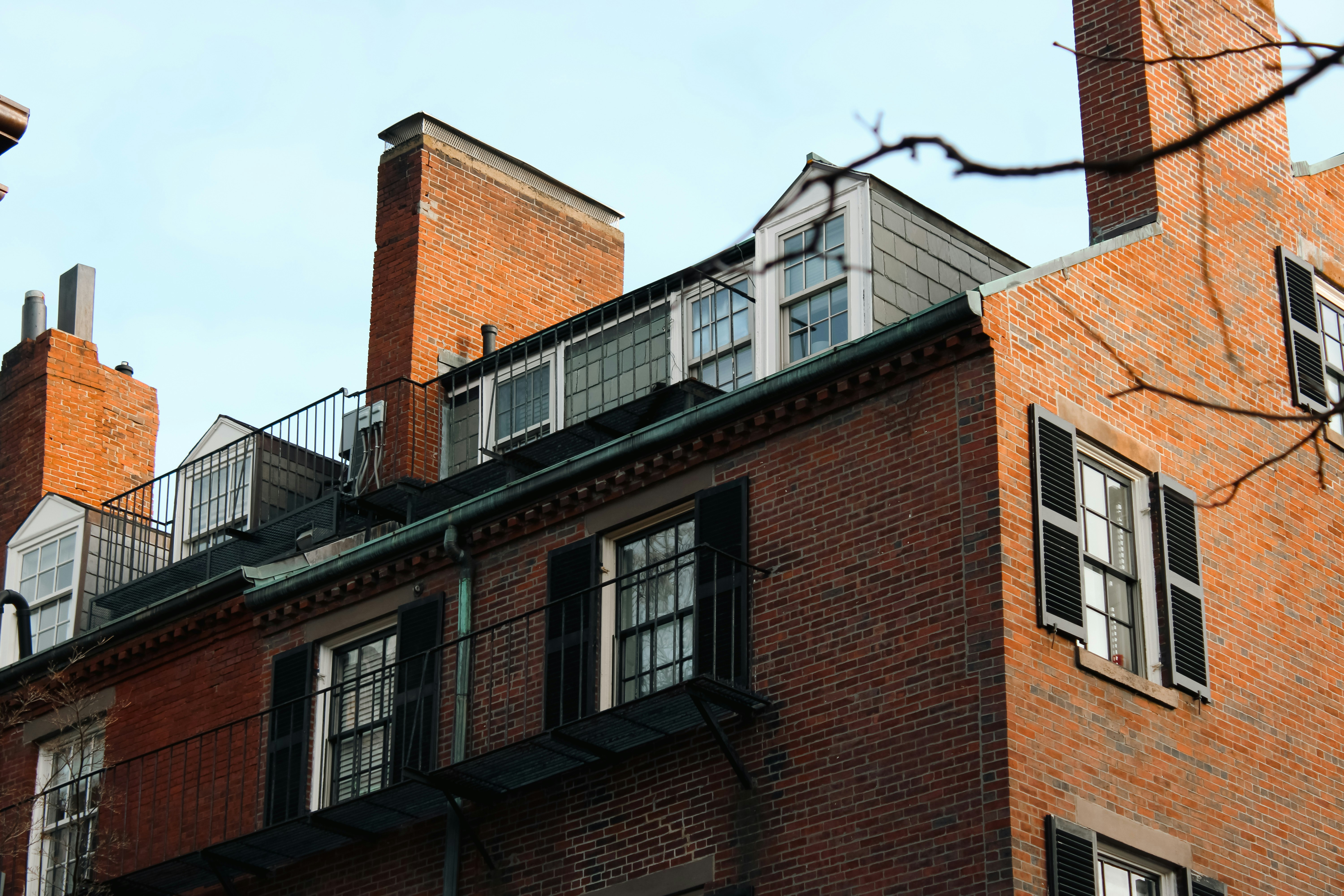 Historic Brick Building with Dormers | Brick buildings with dormer windows against sky