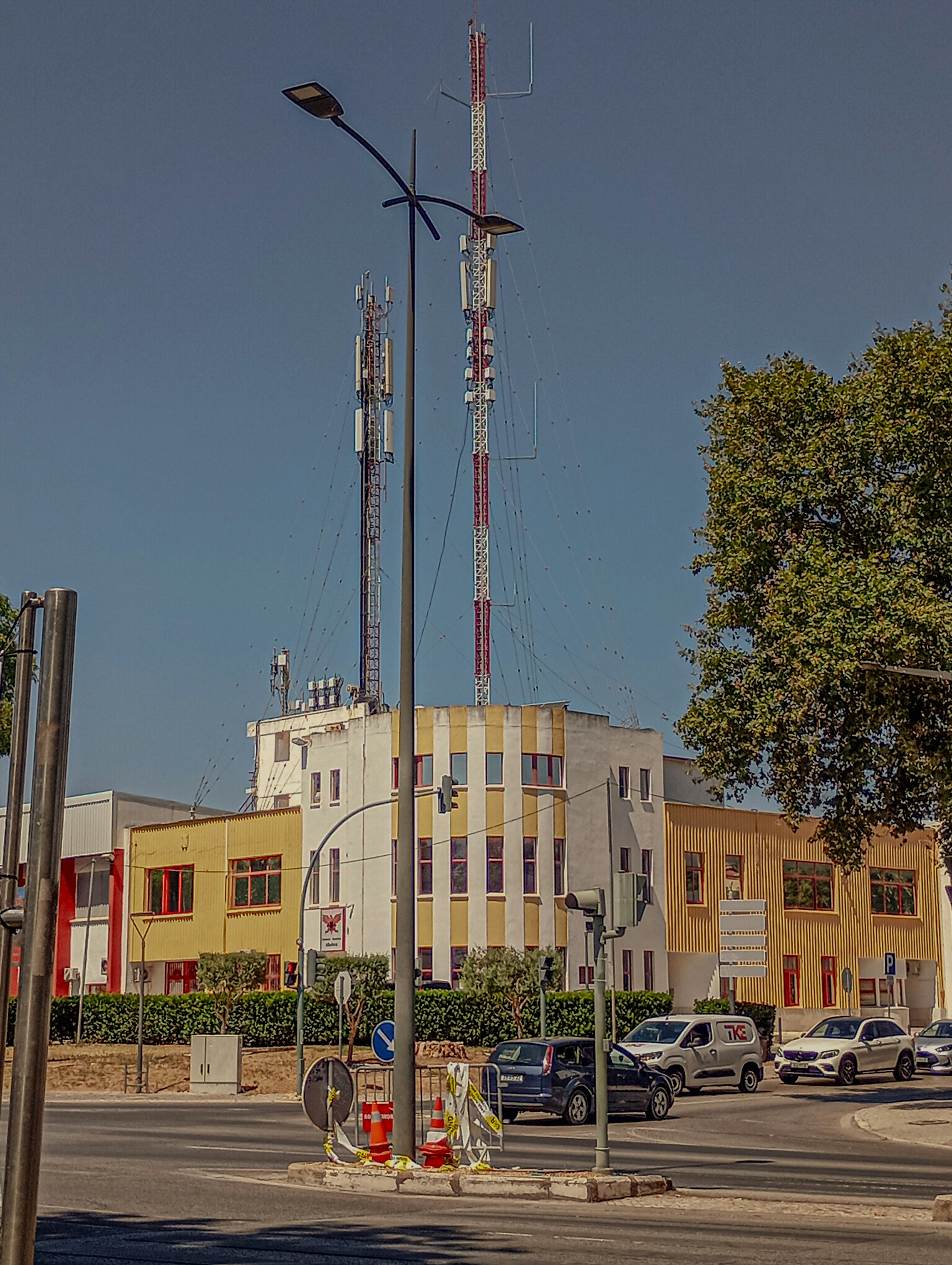 Buildings with communication towers against a clear sky.