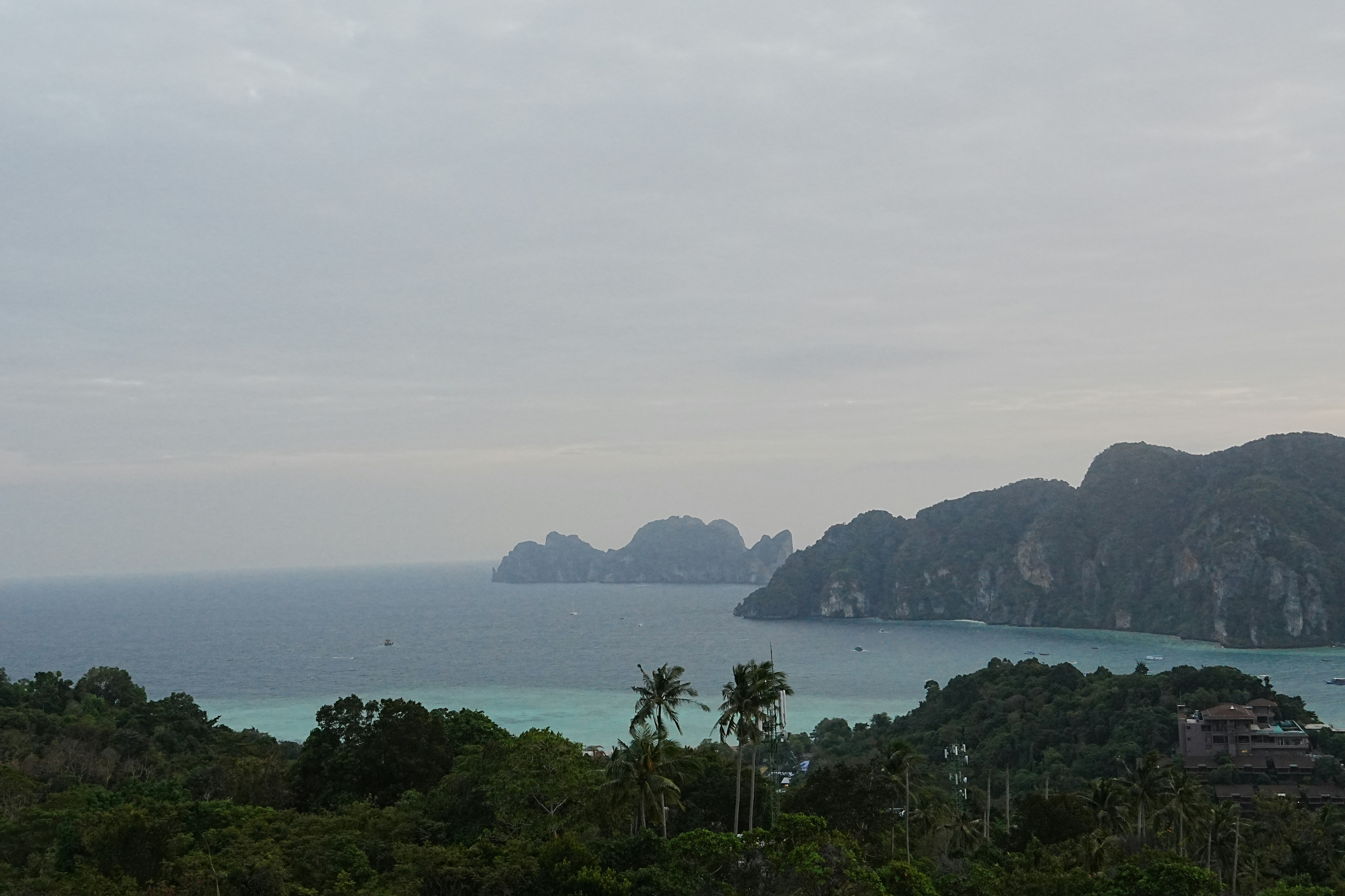 Tropical islands and turquoise water under cloudy sky