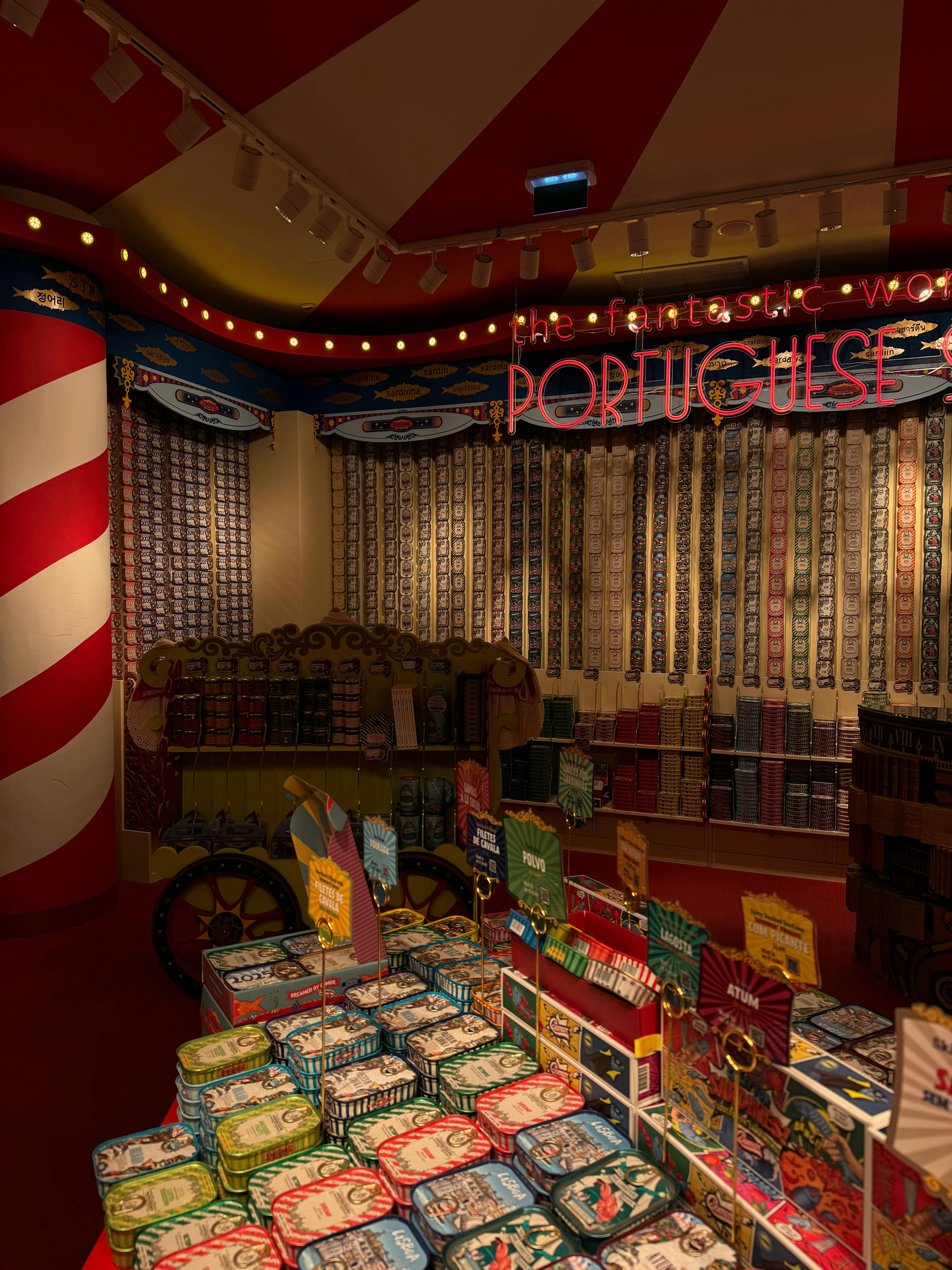 Rows of colorful portuguese sardine tins displayed.