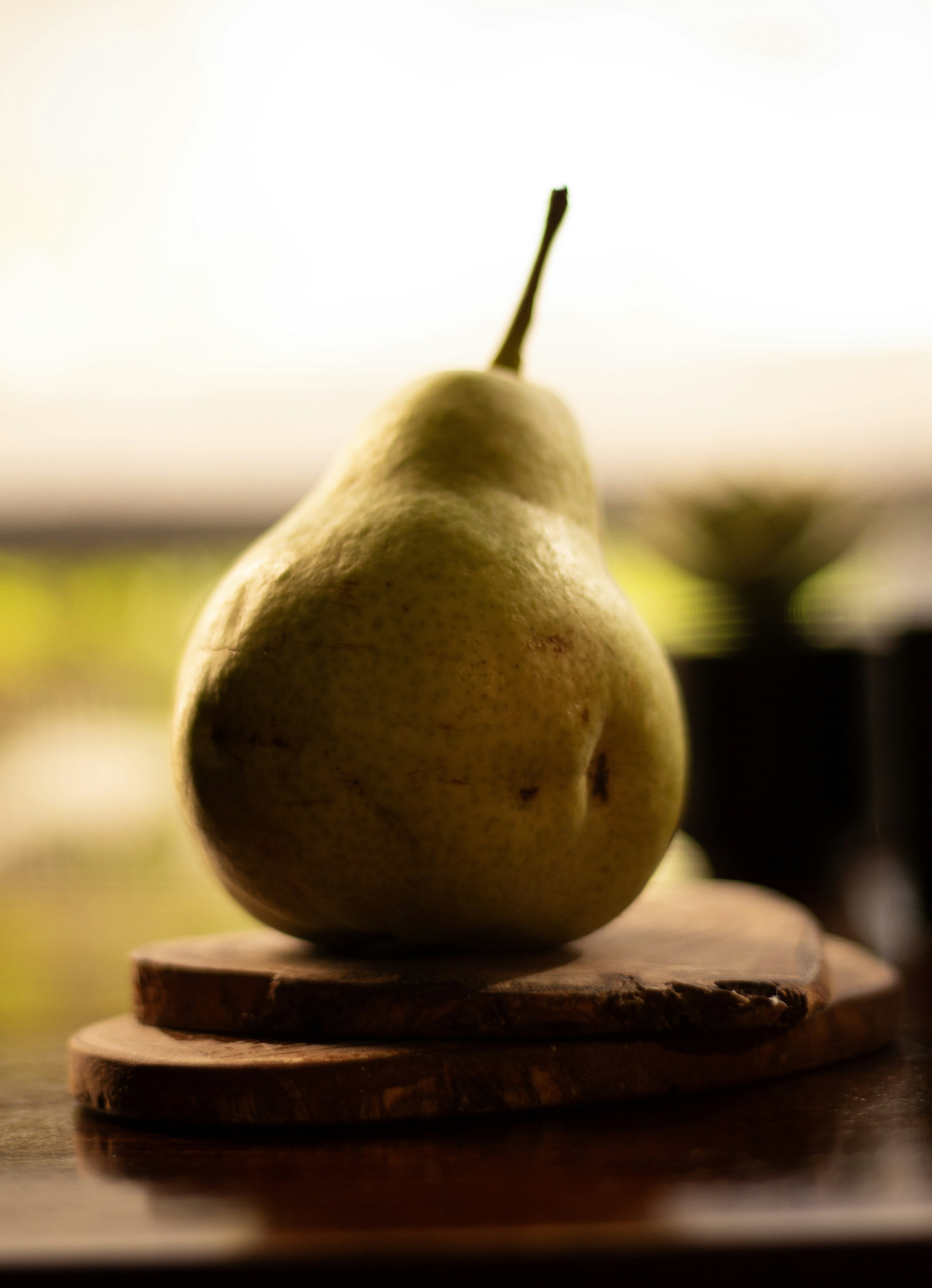 pear, still-life, fruit | A single pear rests on wooden boards.