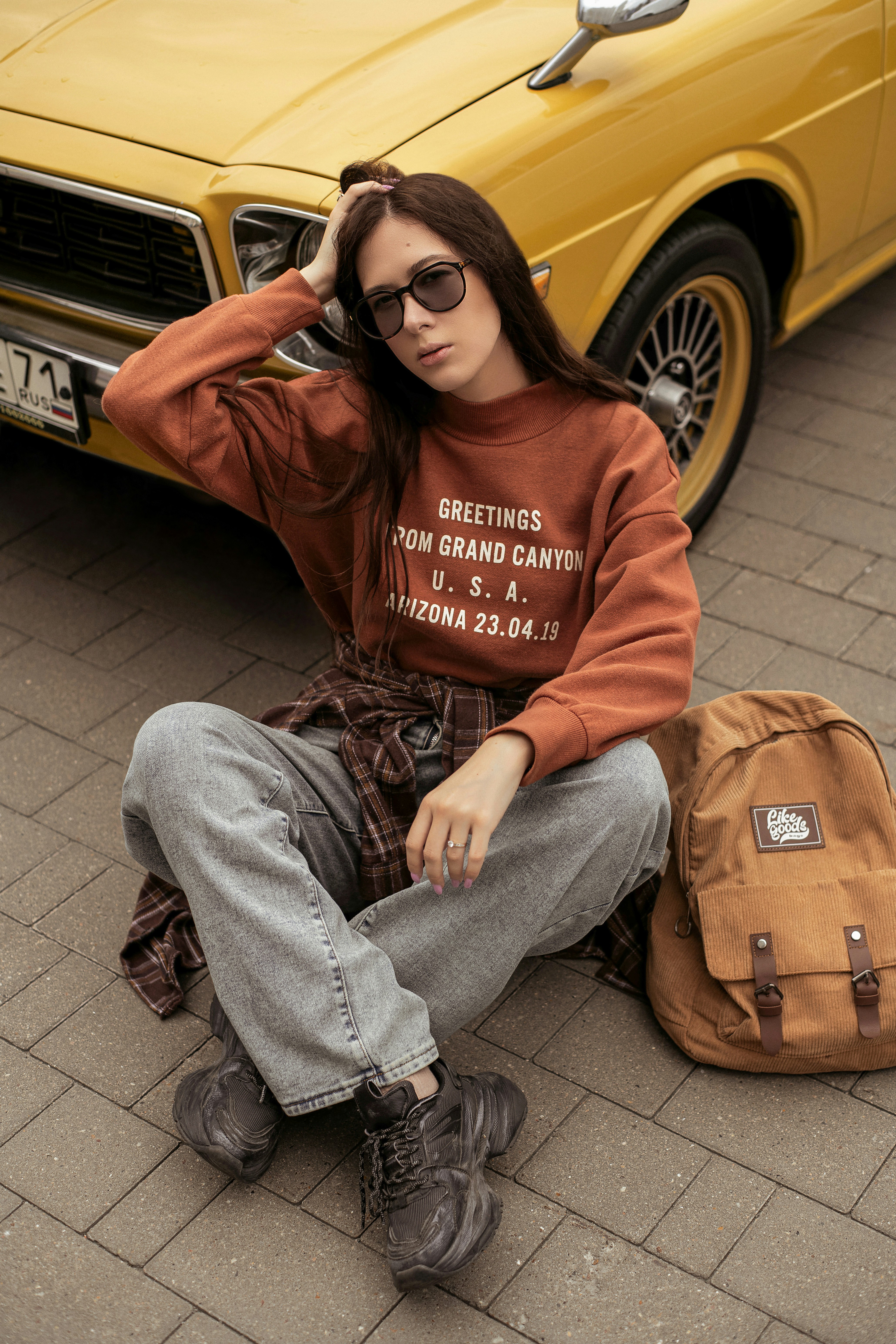 Girl with retro car | Woman in sunglasses sits by a yellow car.