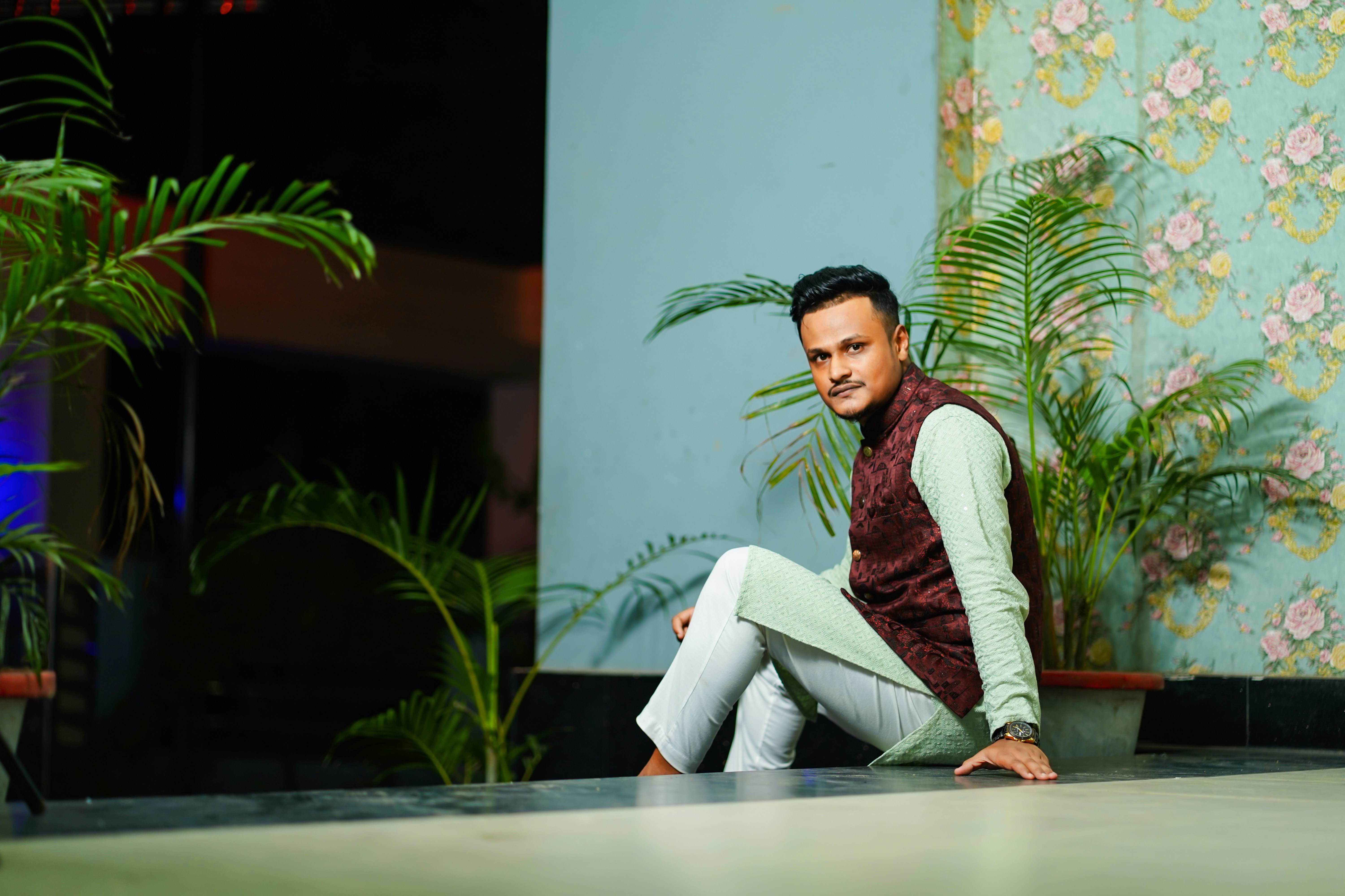 Man in traditional indian attire sitting outdoors