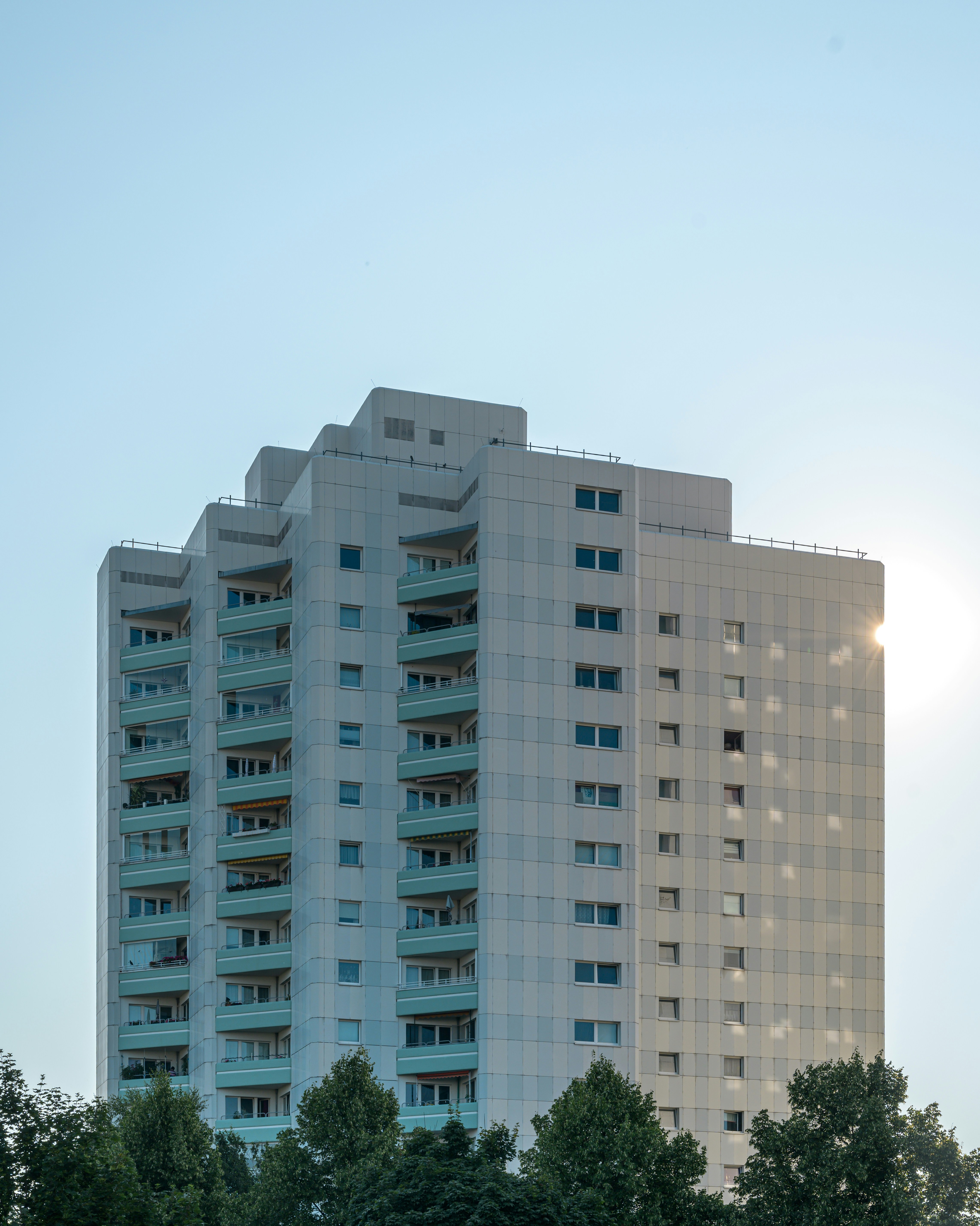 Tall apartment building against a clear sky.
