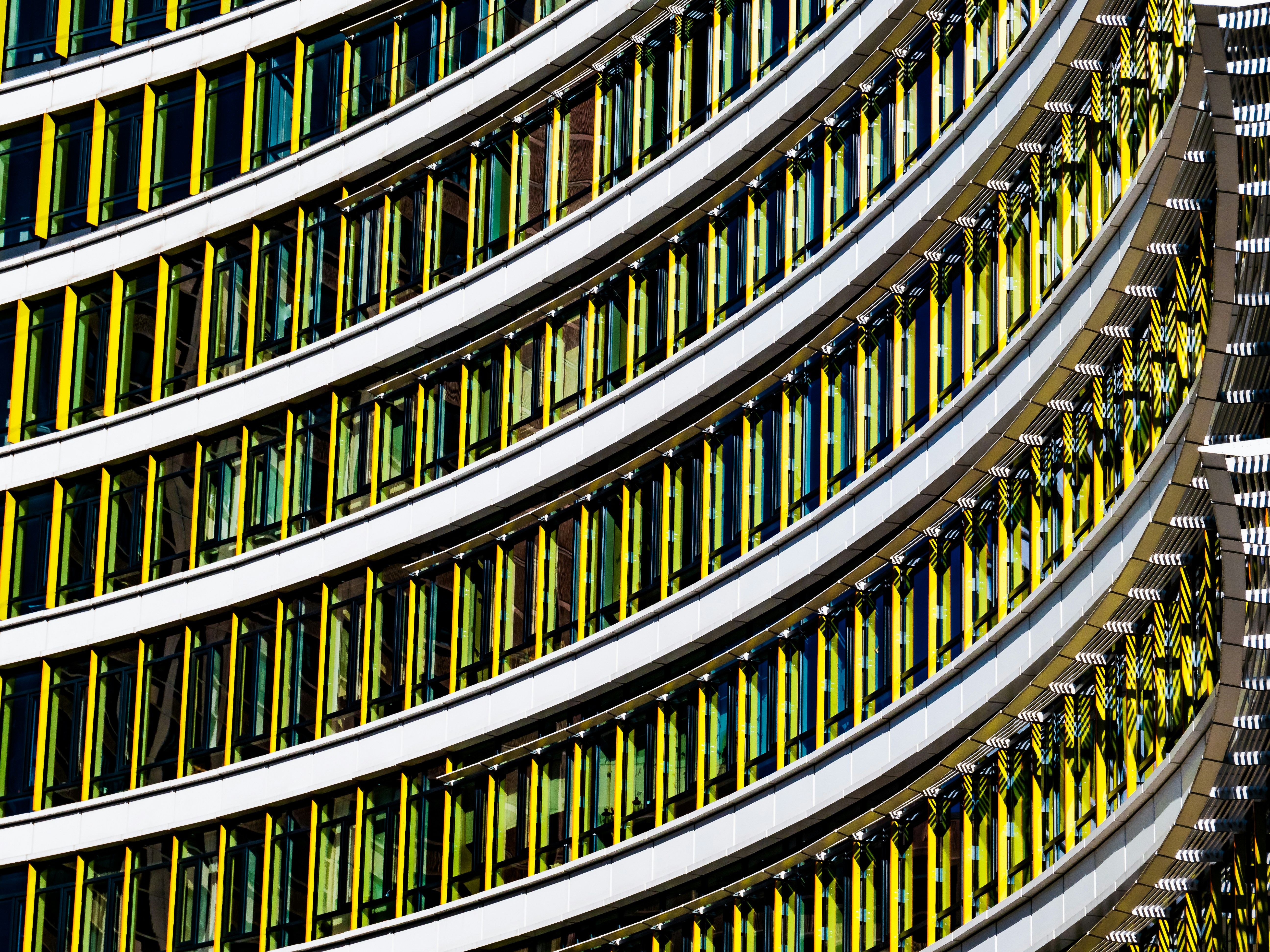 Windows of a building with a round facade | Curved building facade with repeating windows.