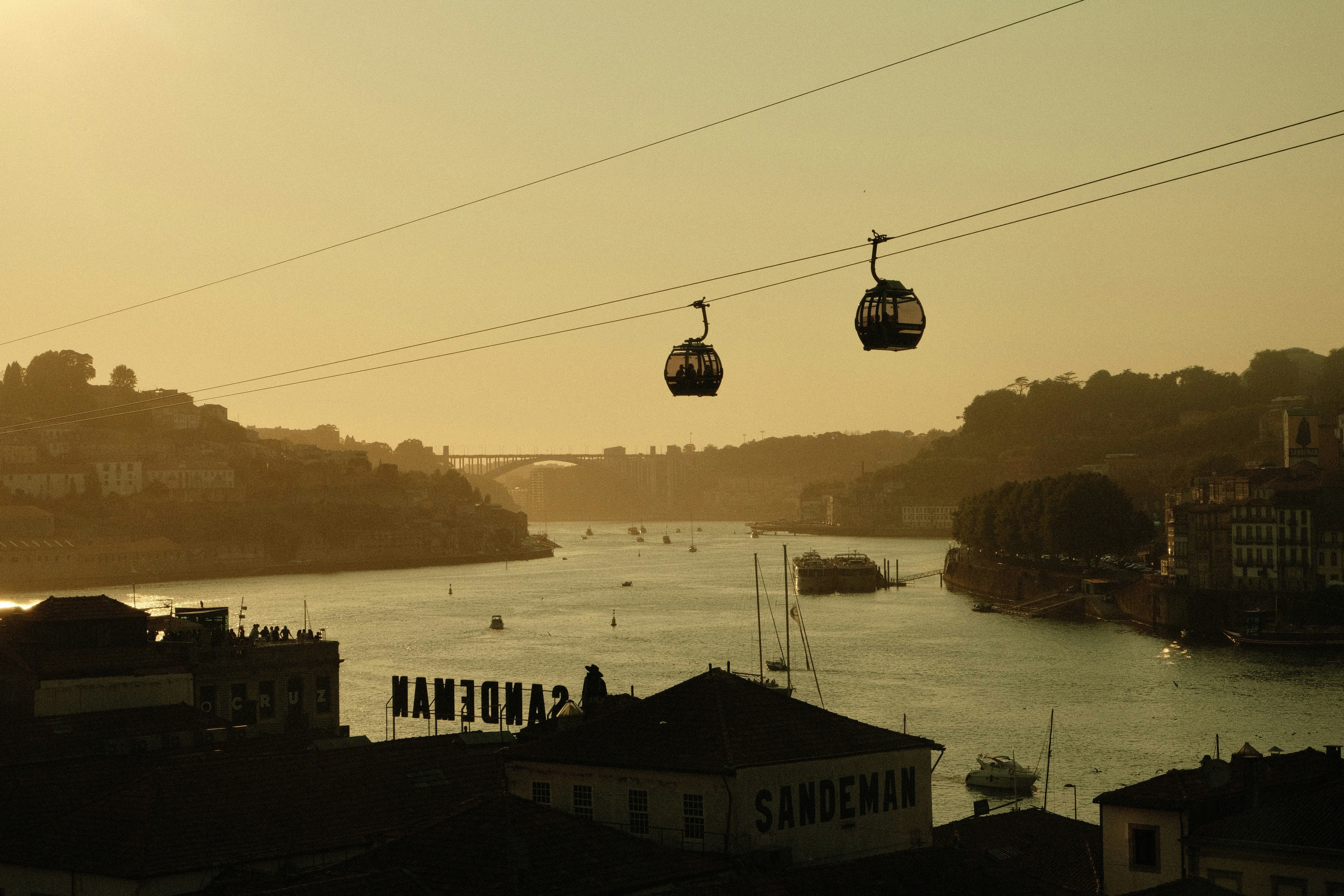 Ride Over the River: A Copper Sunset Above the Cable Cars