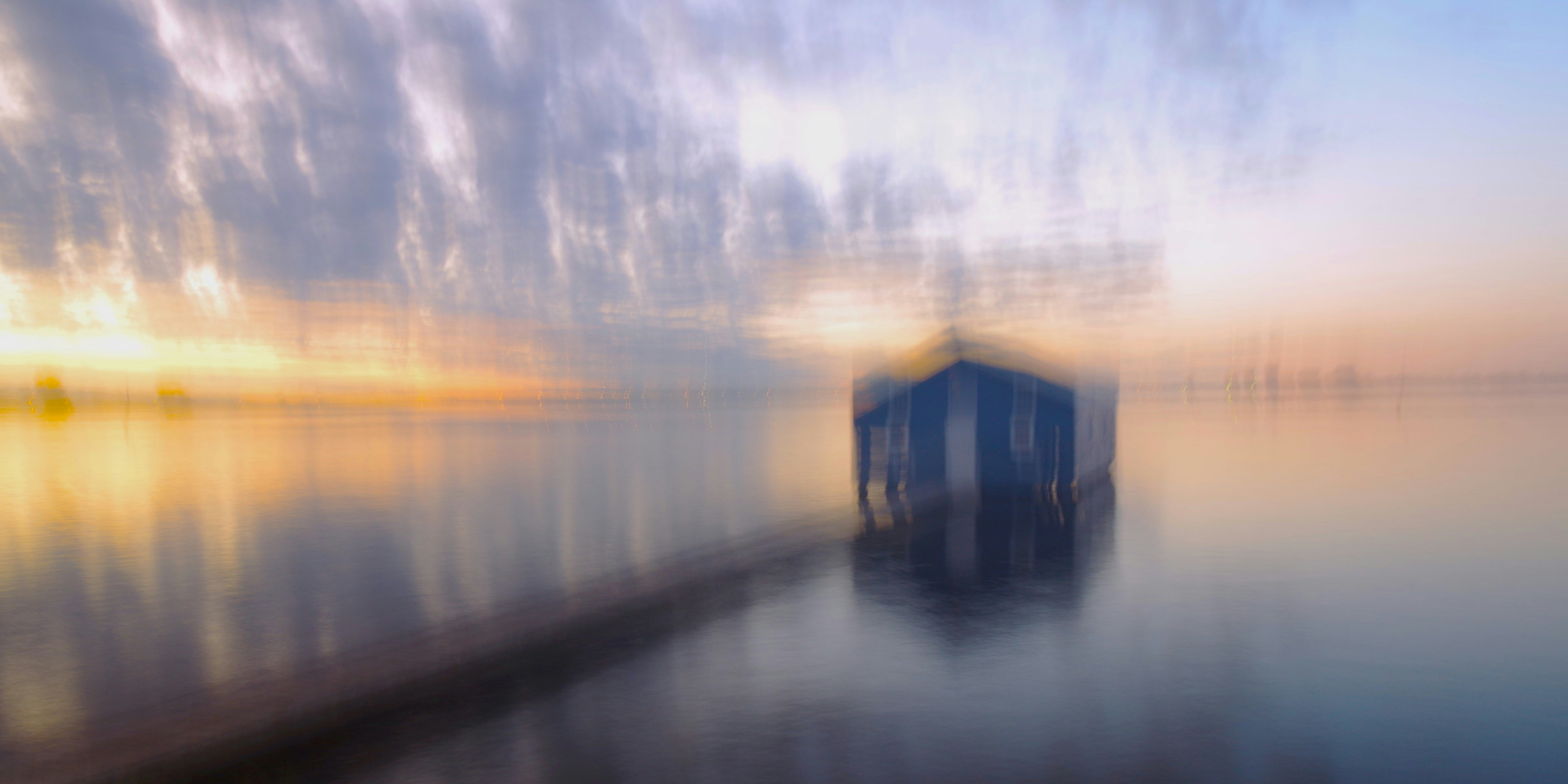 Dusk on a Glass Sea: The Blurred Pierhouse