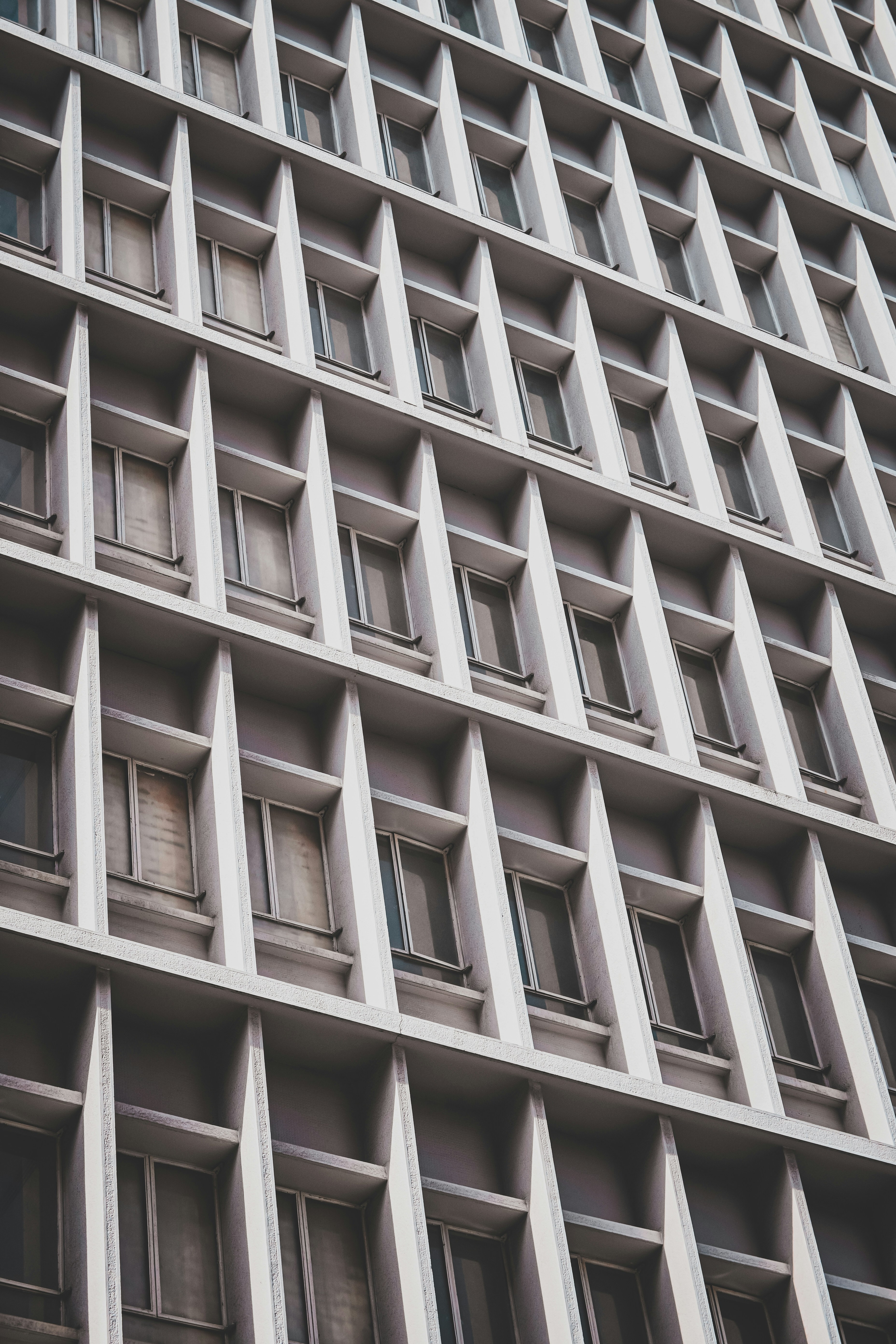 Modern building facade with repeating windows and grid pattern