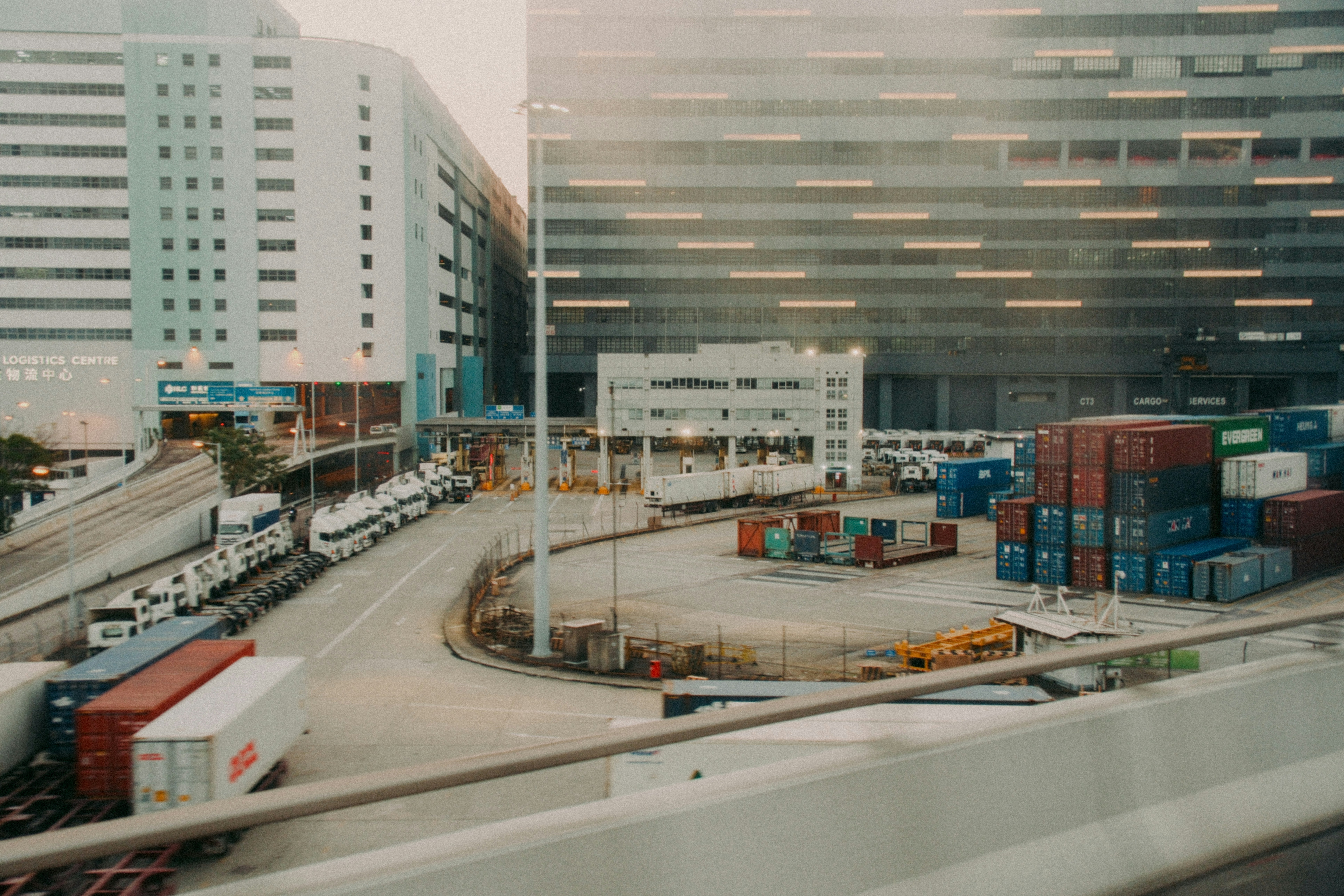 Shipping containers and trucks at a logistics hub