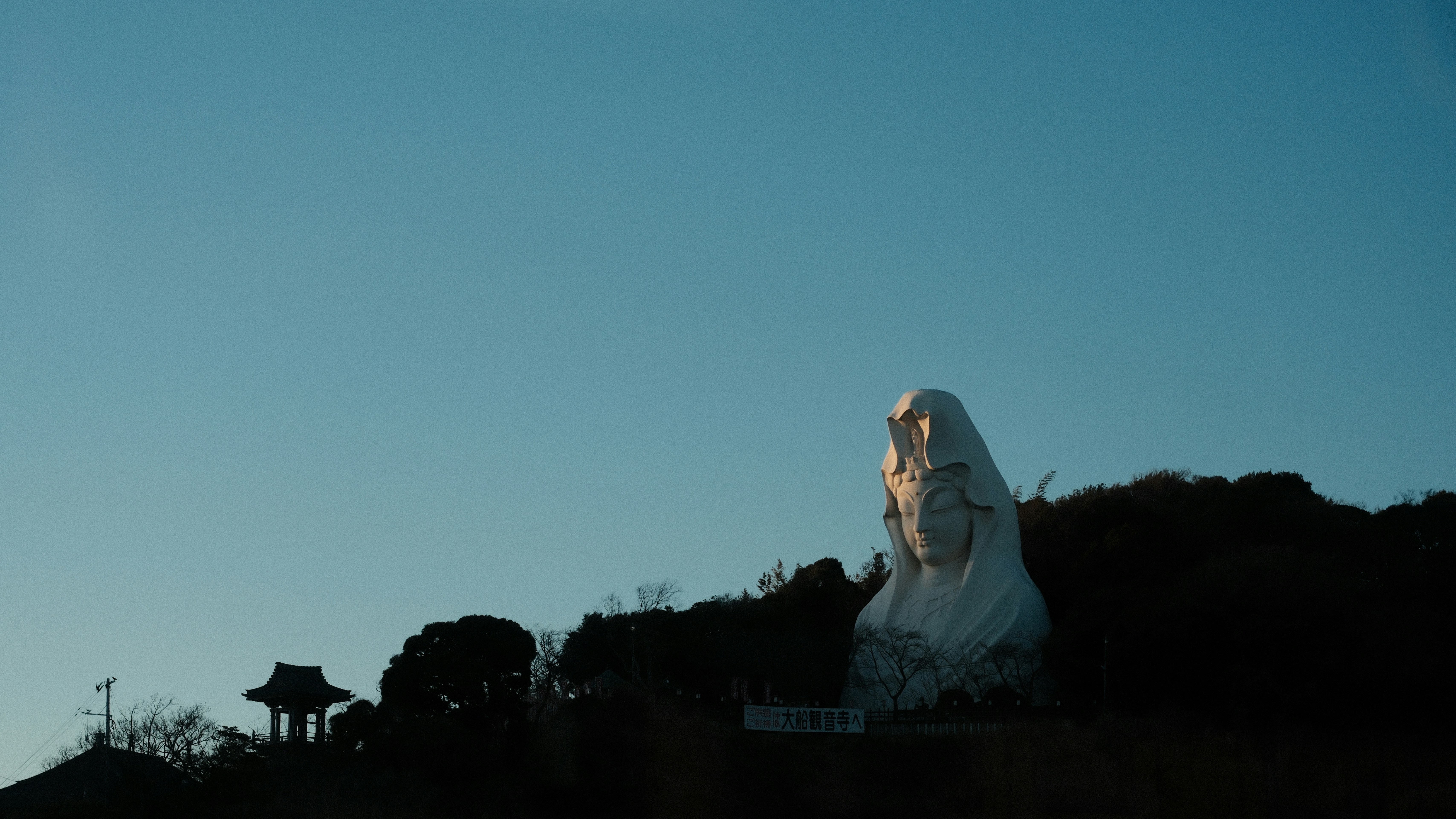 Guardian of Serenity: The Majestic White Statue at Dusk