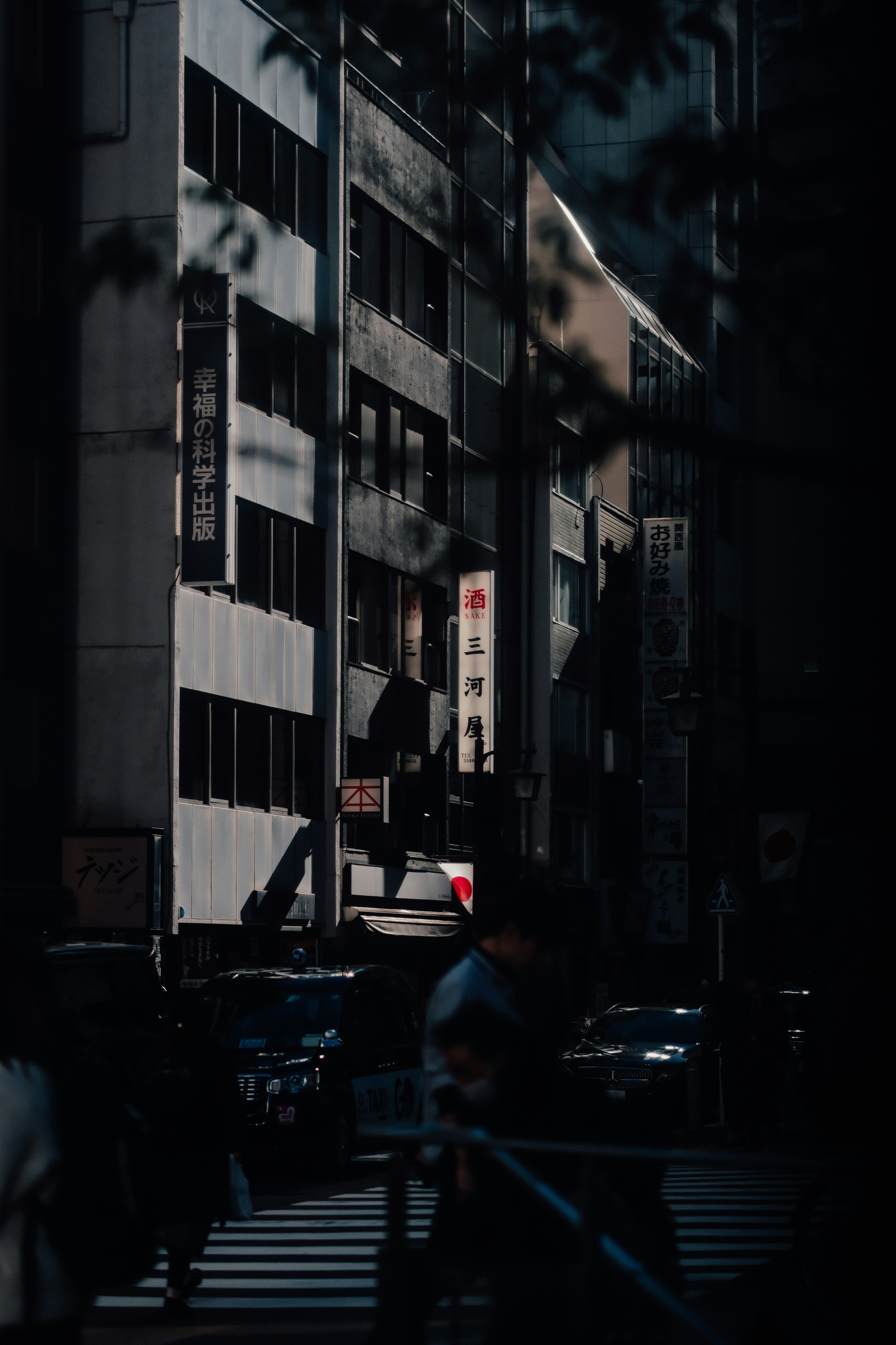 City street with buildings and people crossing
