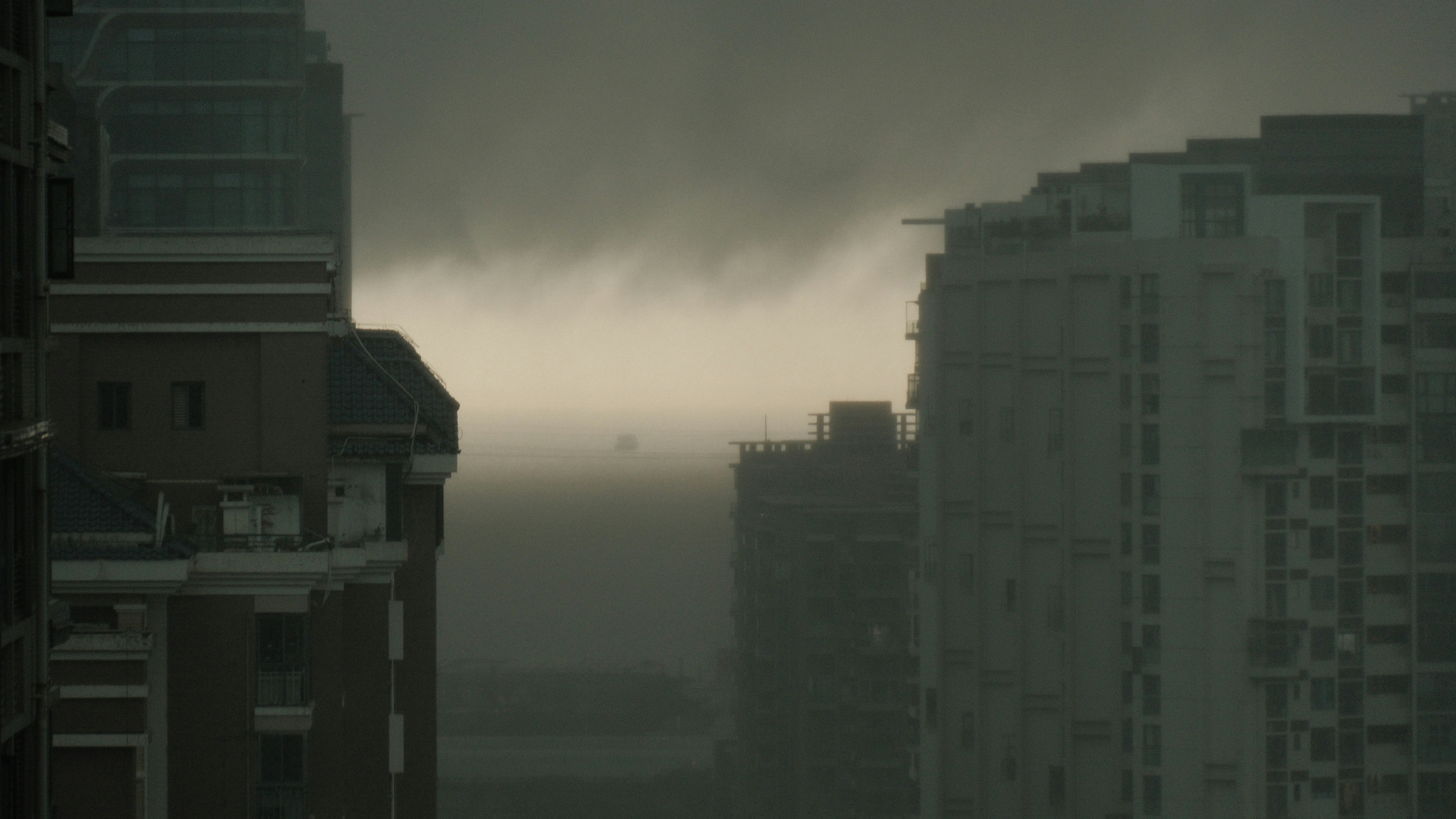City skyline shrouded in heavy fog or clouds