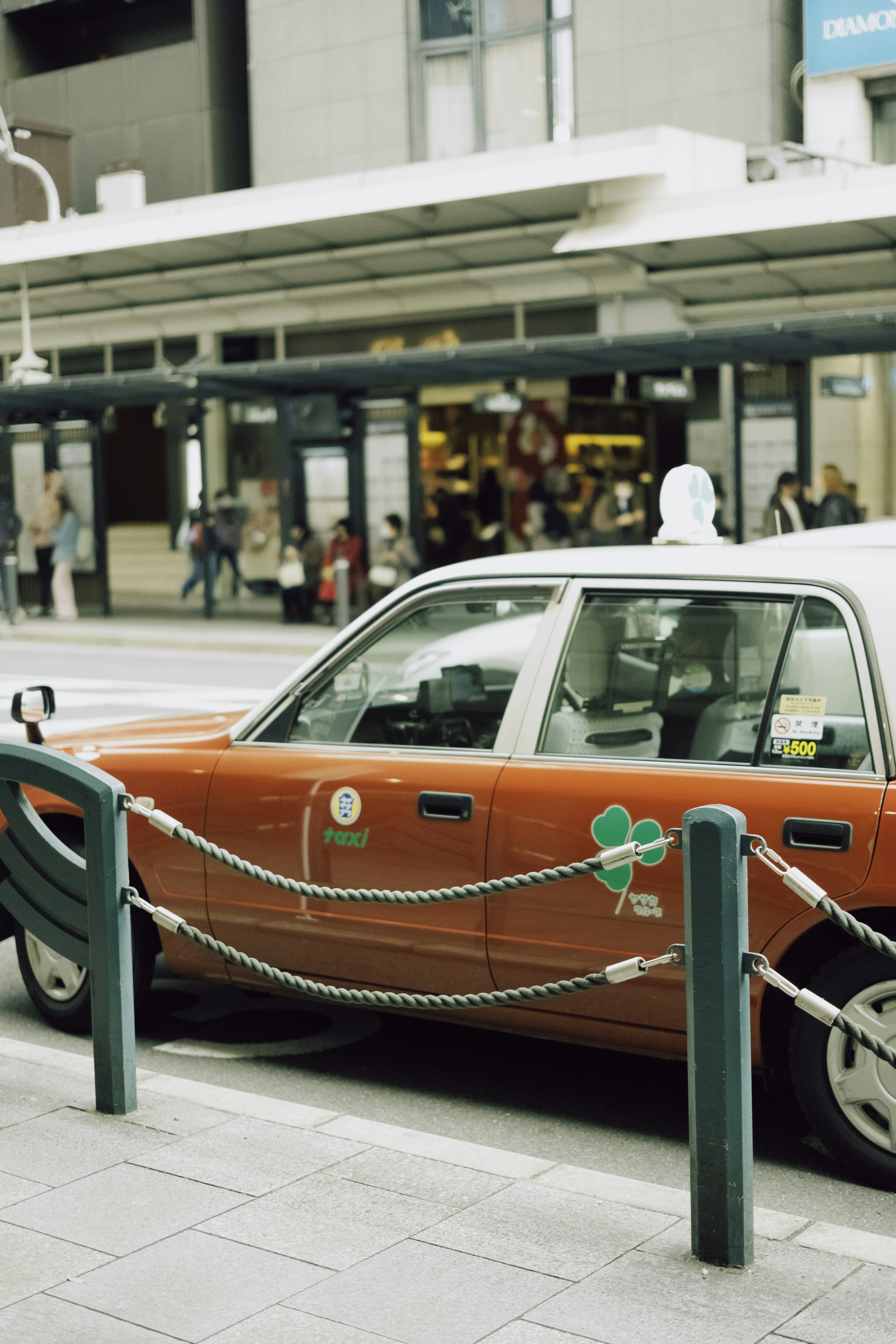 Orange Taxi at the Edge of a Quiet City Street