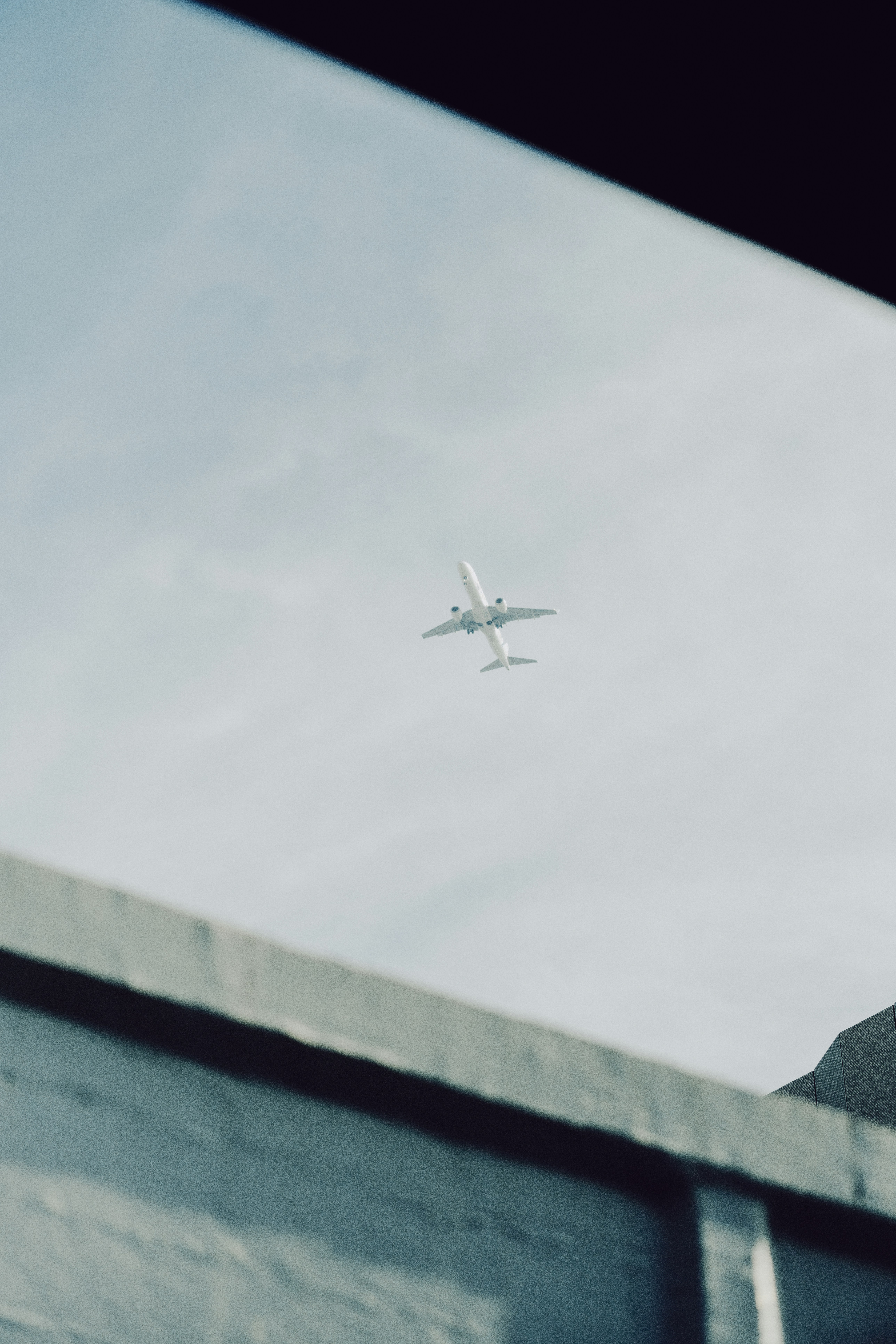 Jet Above the Rooftop Edge: A Quiet Moment in the Urban Sky