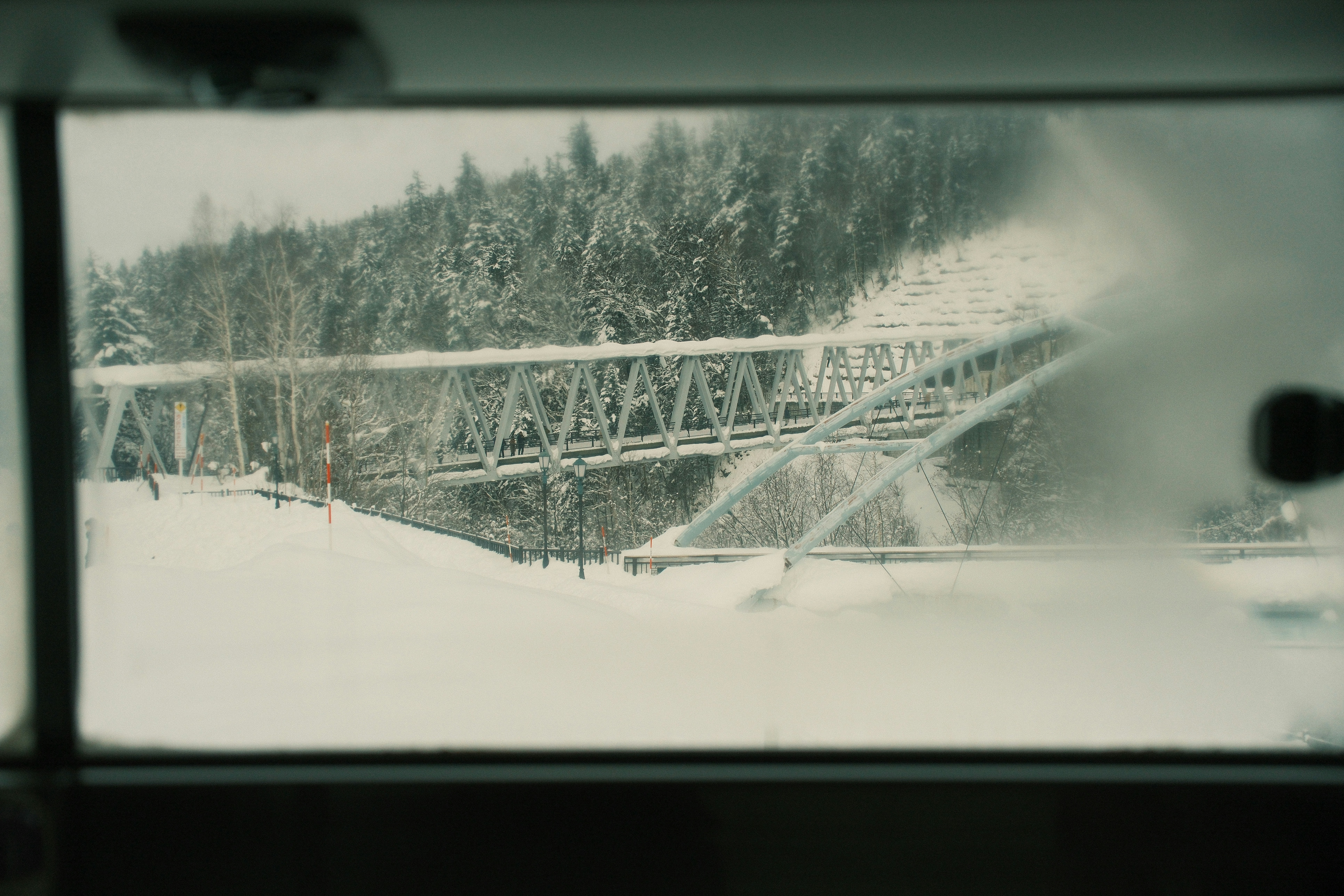 Snowbound Corridor: Bridge Through a Frosted Window