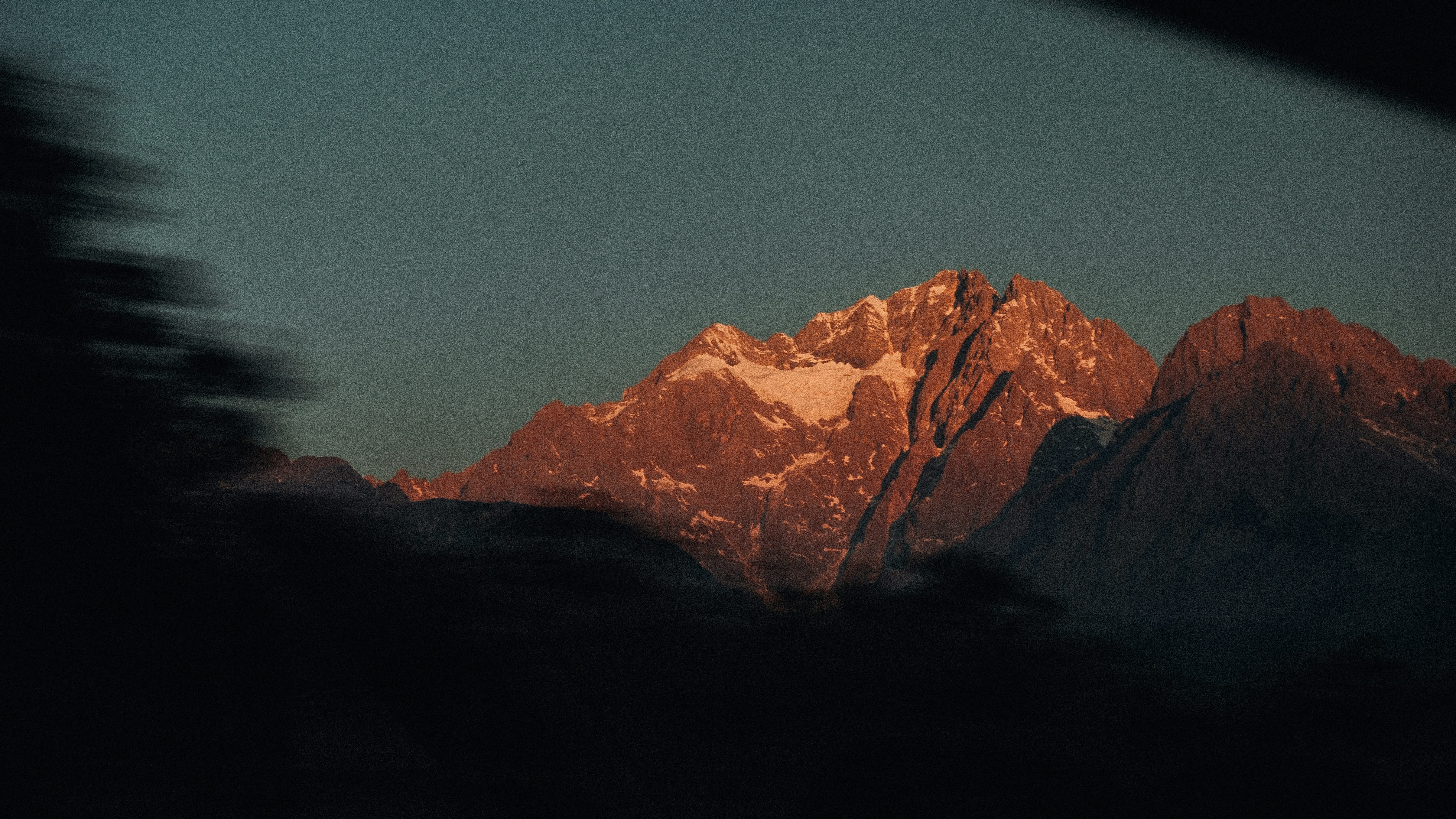 Majestic mountain peak bathed in golden sunset light.