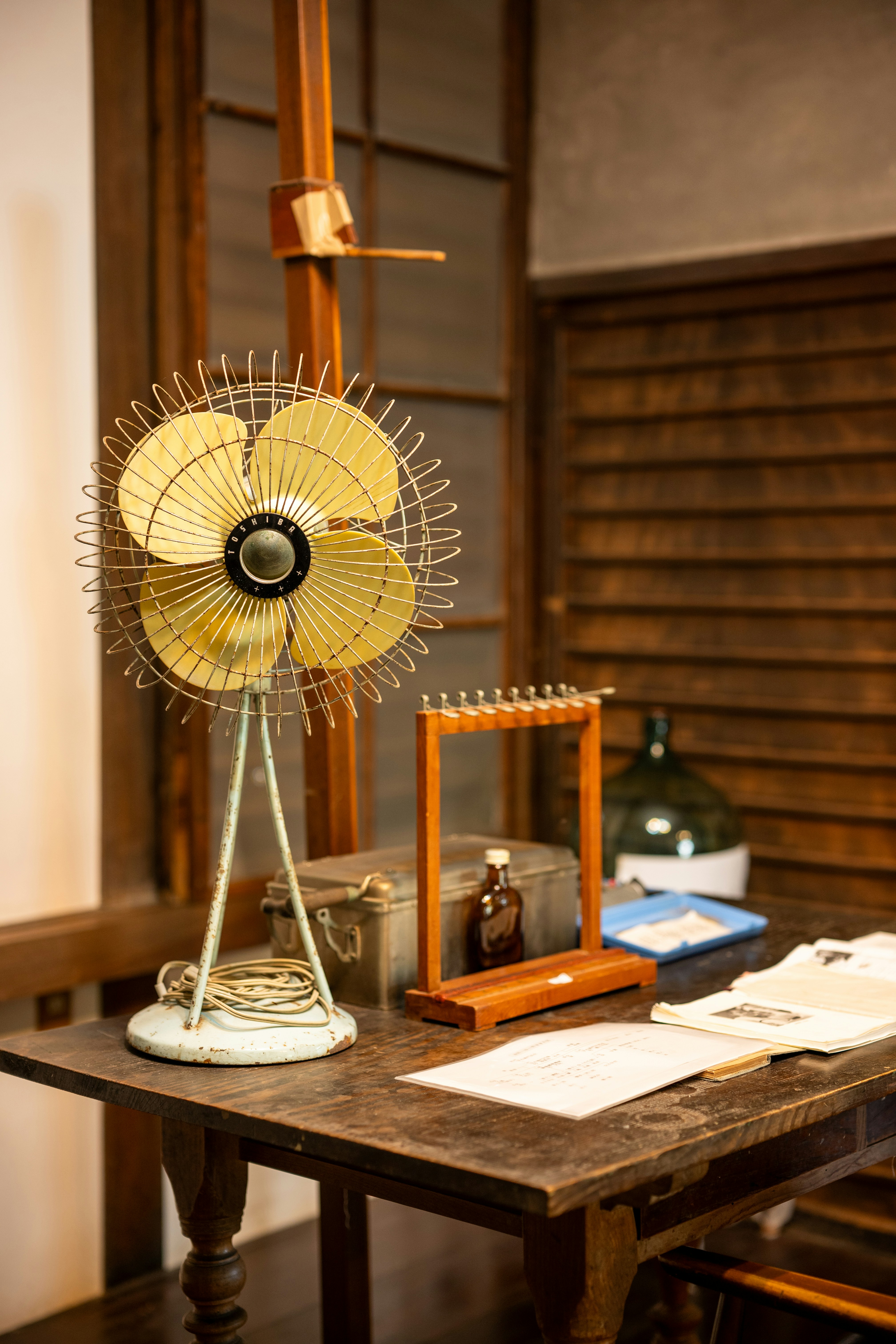 Vintage fan and objects on a wooden table