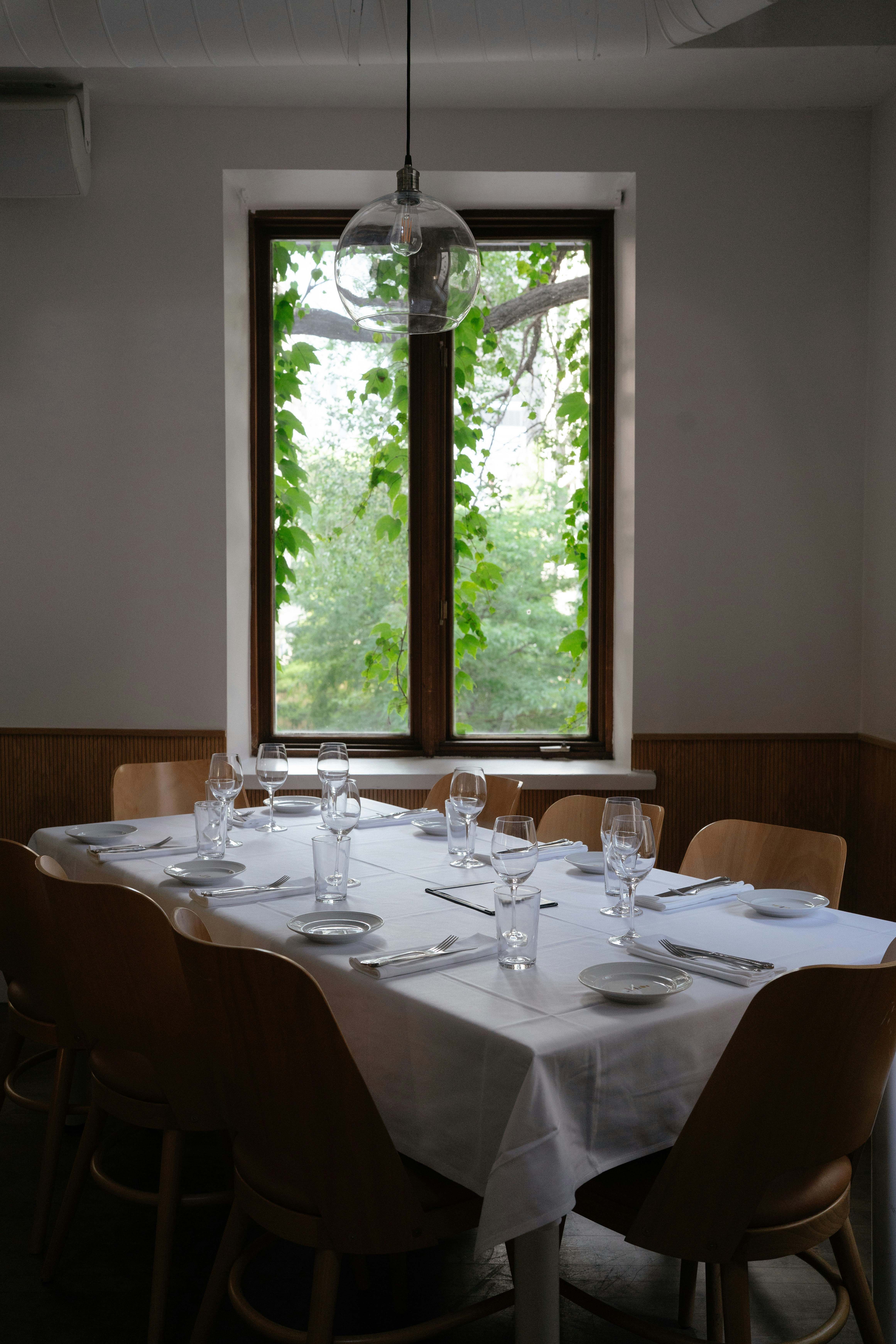 Set dining table with white tablecloth and glasses